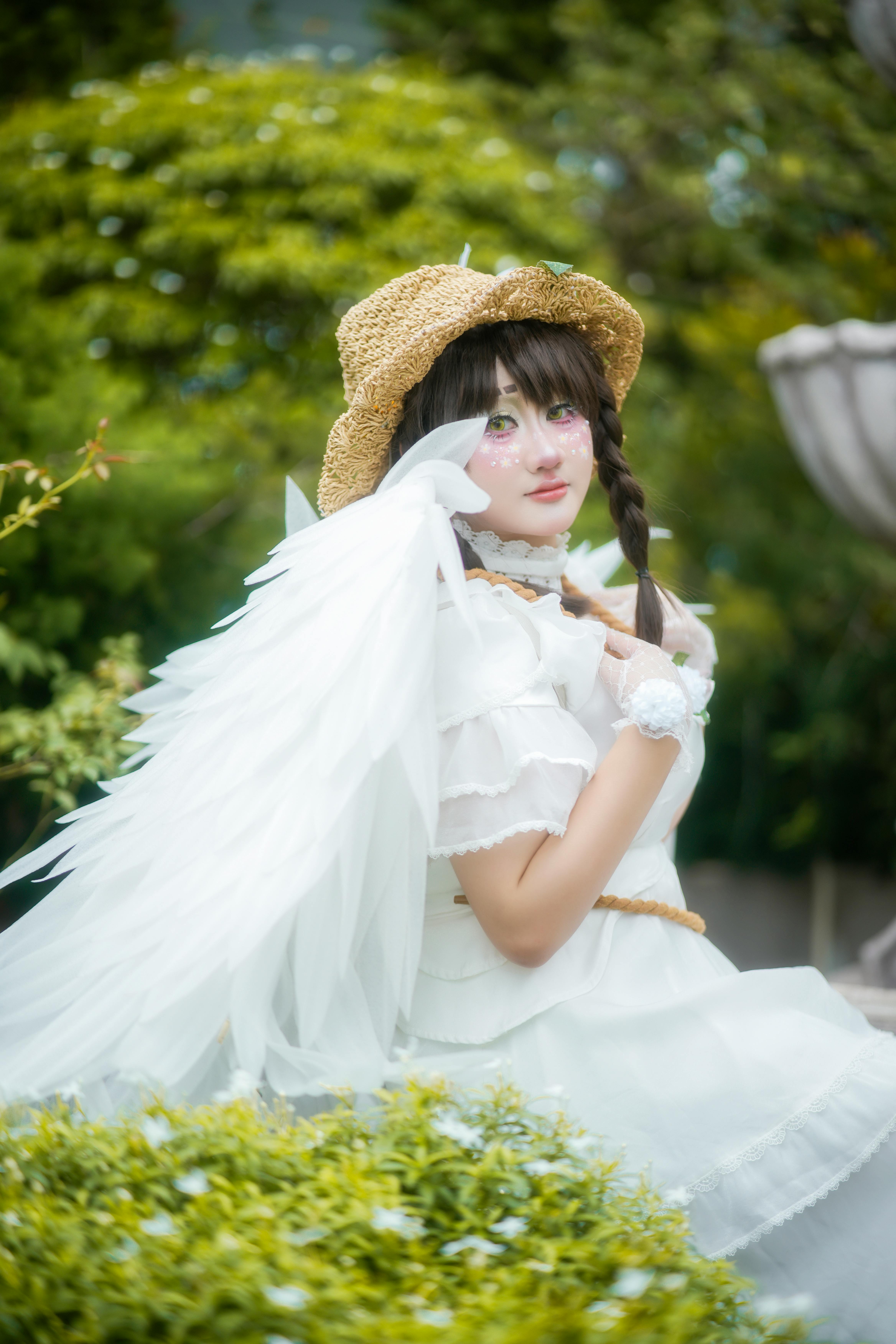 Elegant Angelic Cosplay in Lush Garden Setting · Free Stock Photo