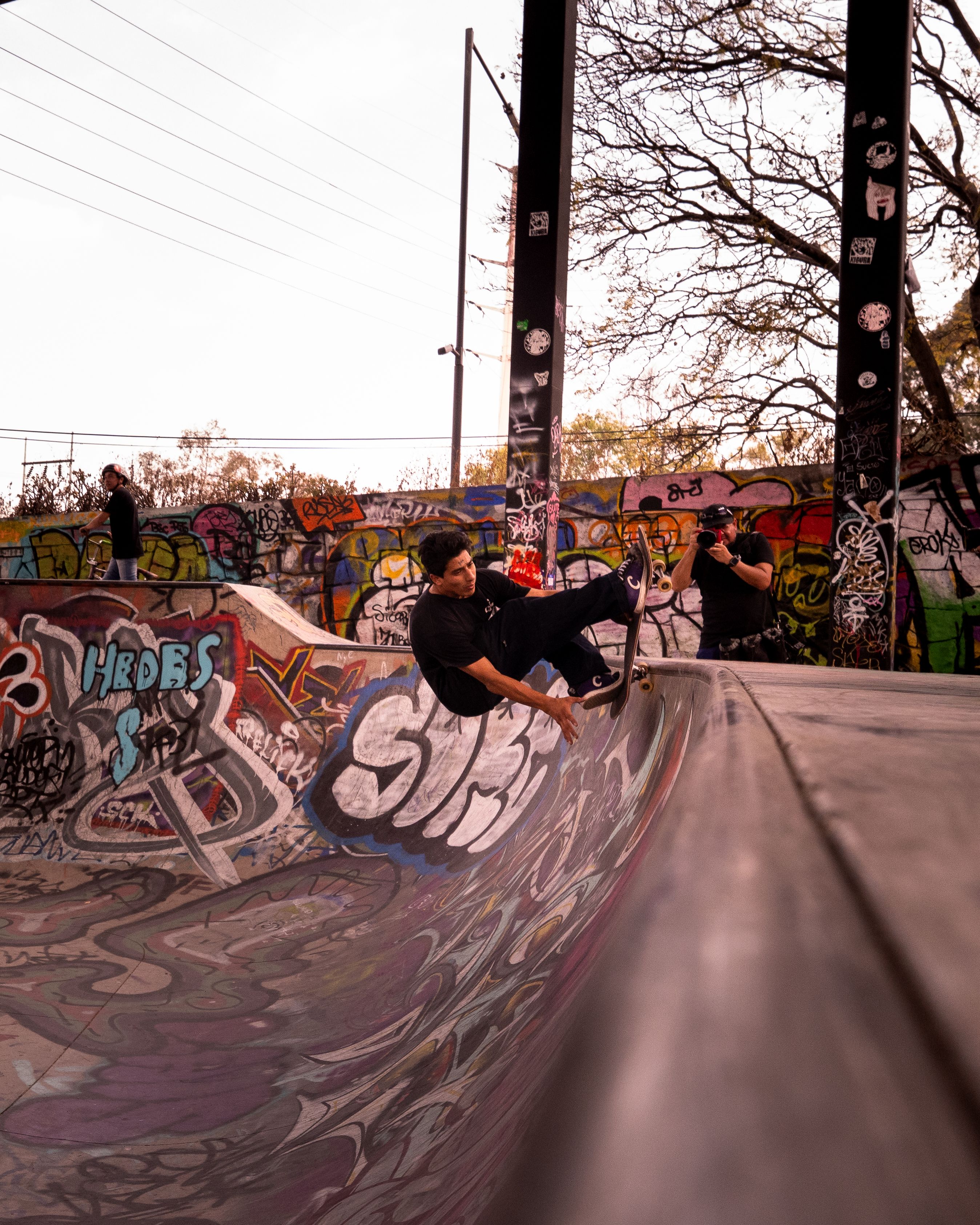 Skateboarder Performing Trick in Graffiti Skatepark · Free Stock Photo