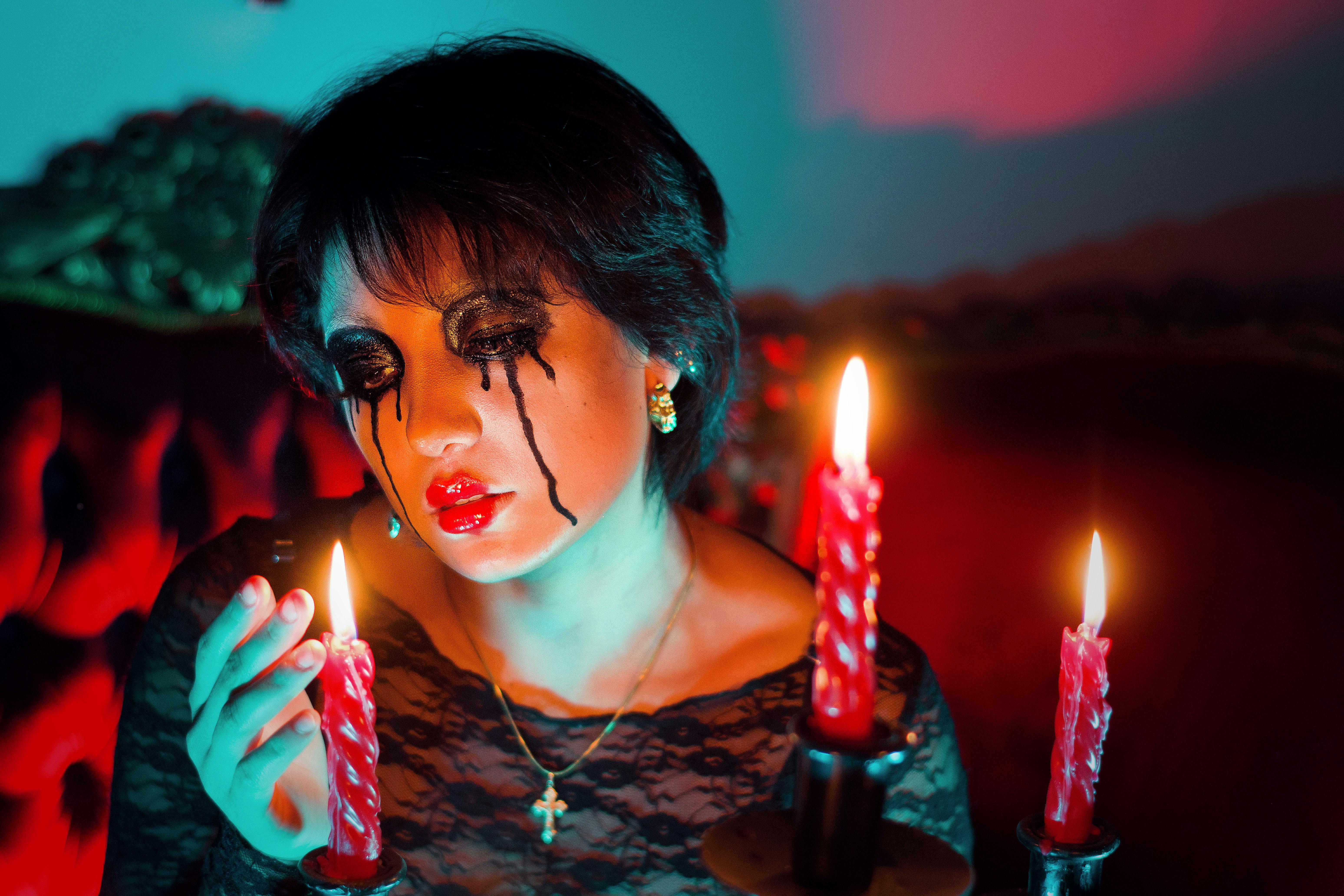 Dramatic Portrait with Candles in Gothic Setting · Free Stock Photo
