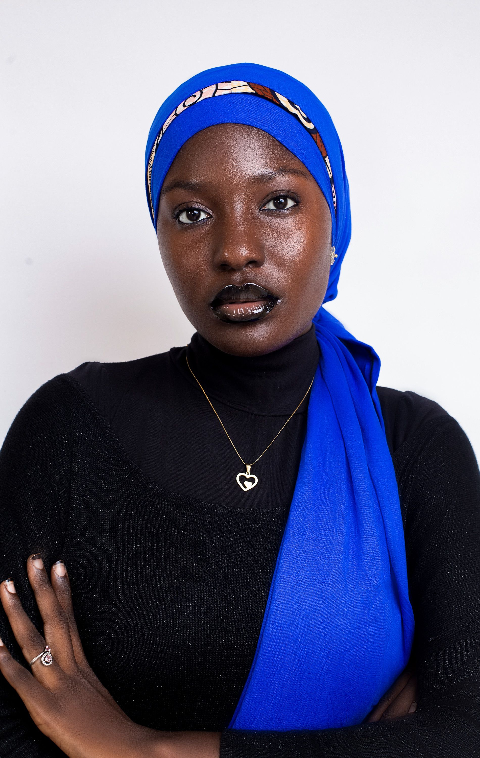 Elegant Portrait of Woman in Vibrant Blue Headscarf · Free Stock Photo