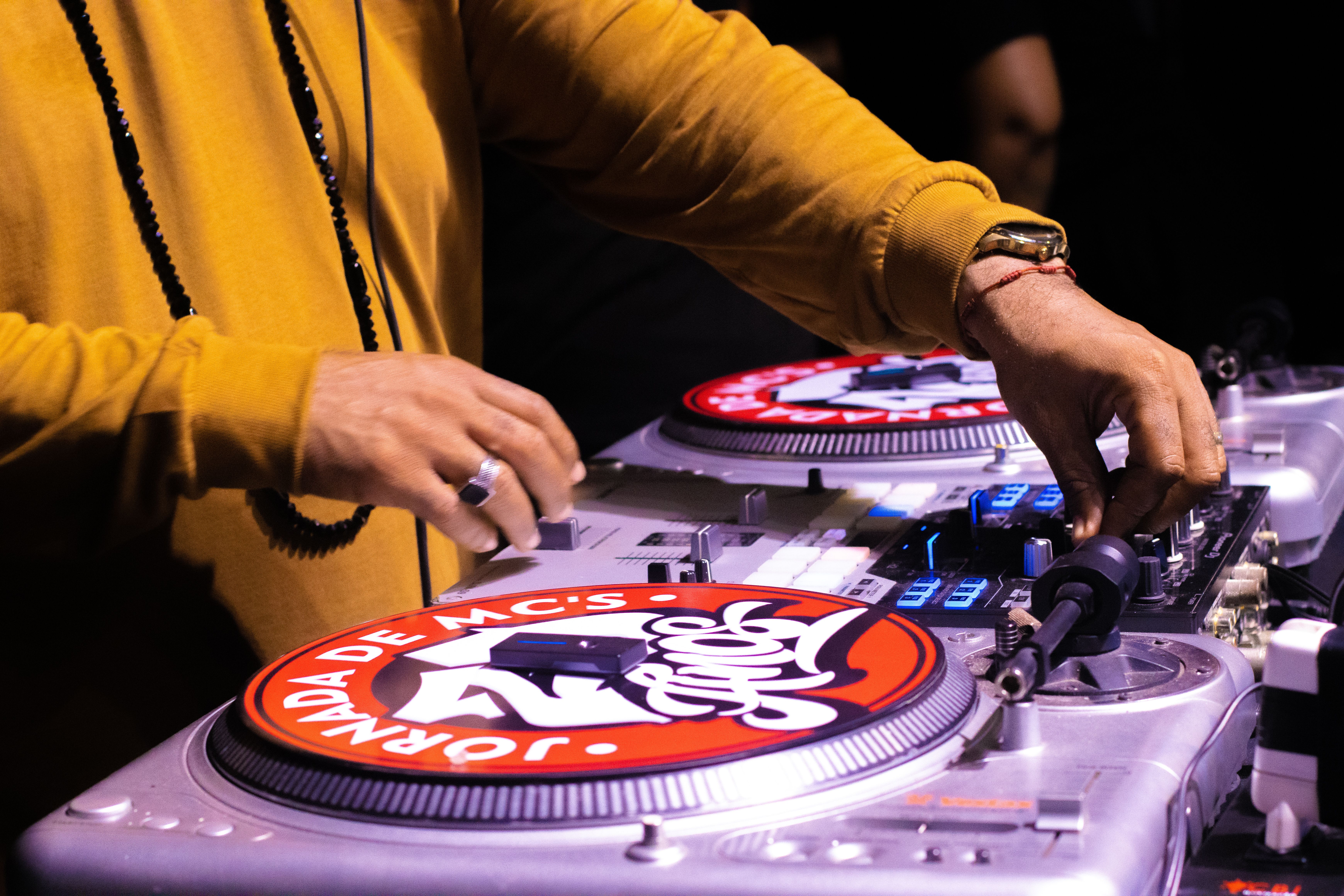 DJ Mixing Music on Turntables in Club Setting · Free Stock Photo