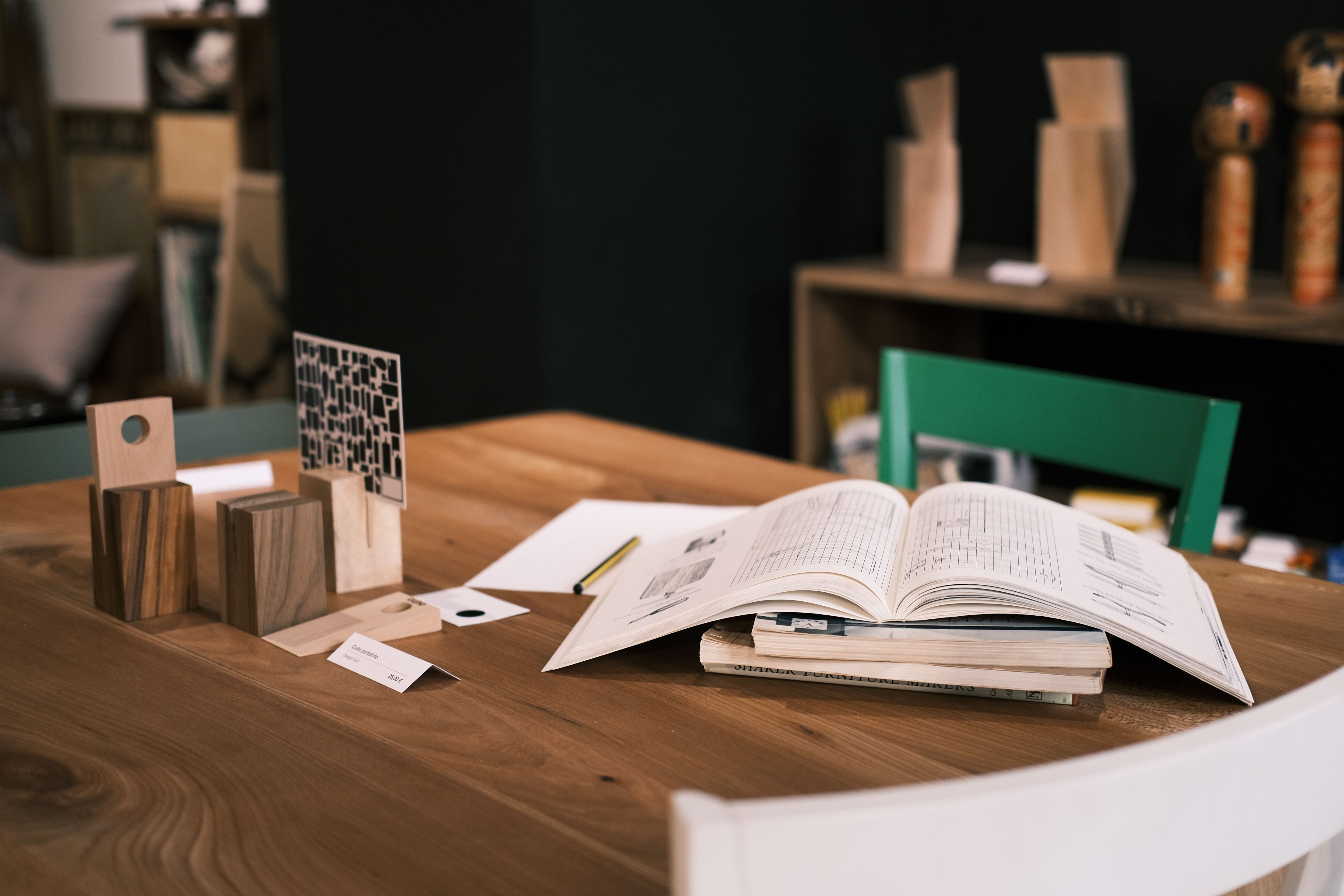 Modern Workspace with Open Book and Wooden Decor · Free Stock Photo