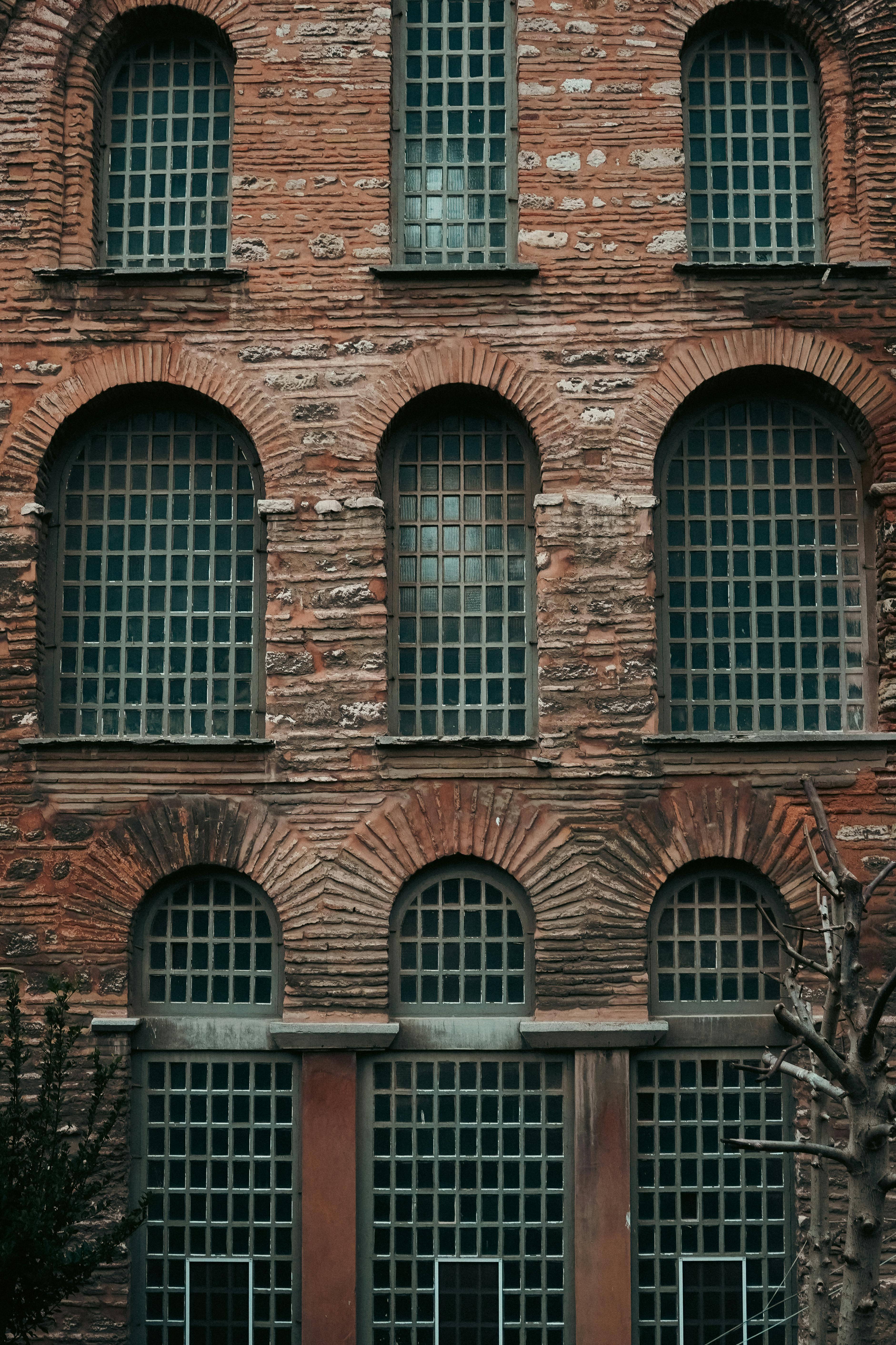 Historic Brick Facade with Arched Windows · Free Stock Photo