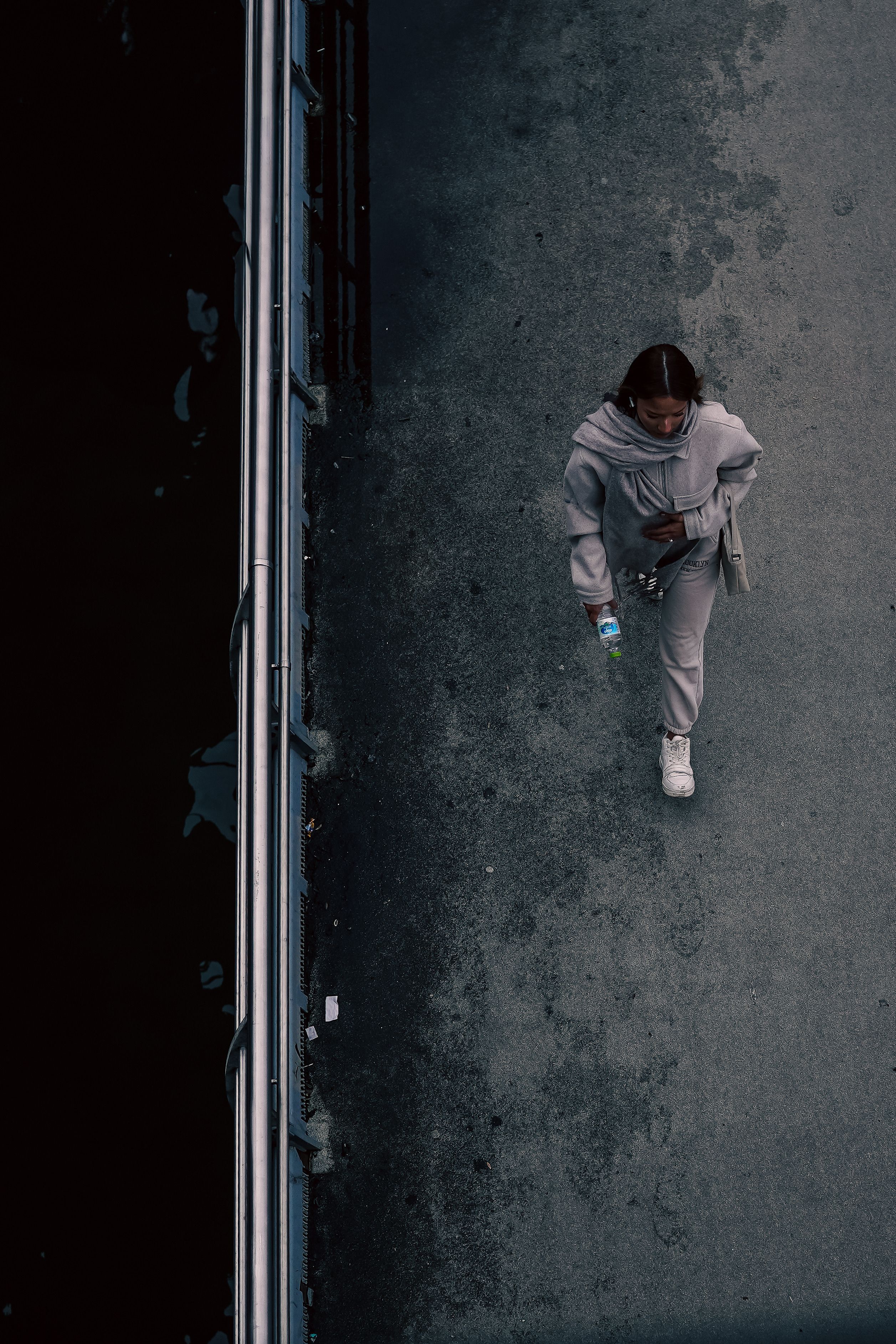 Aerial View of Woman Walking with Bottle Outdoors · Free Stock Photo