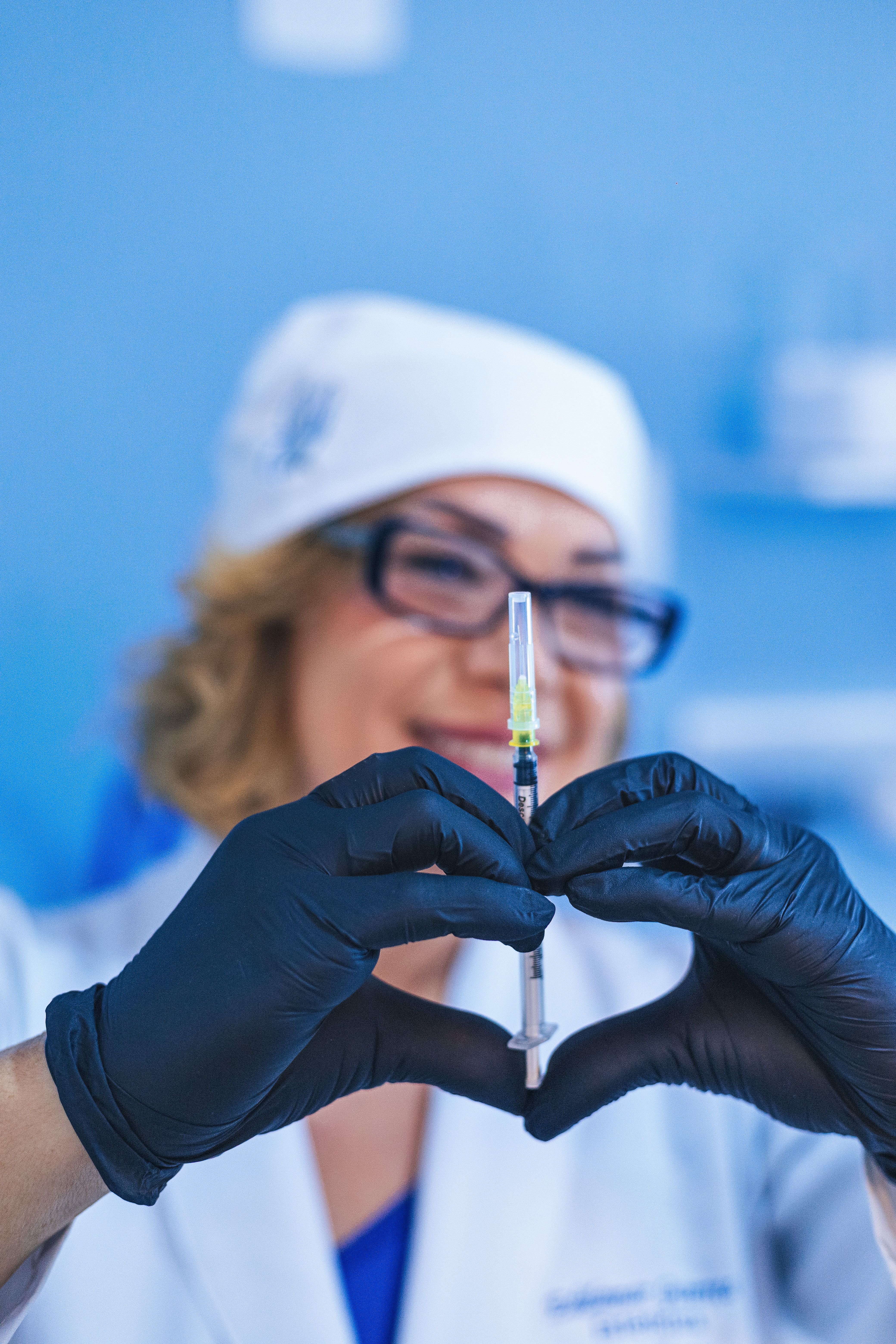 Healthcare professional preparing a syringe · Free Stock Photo