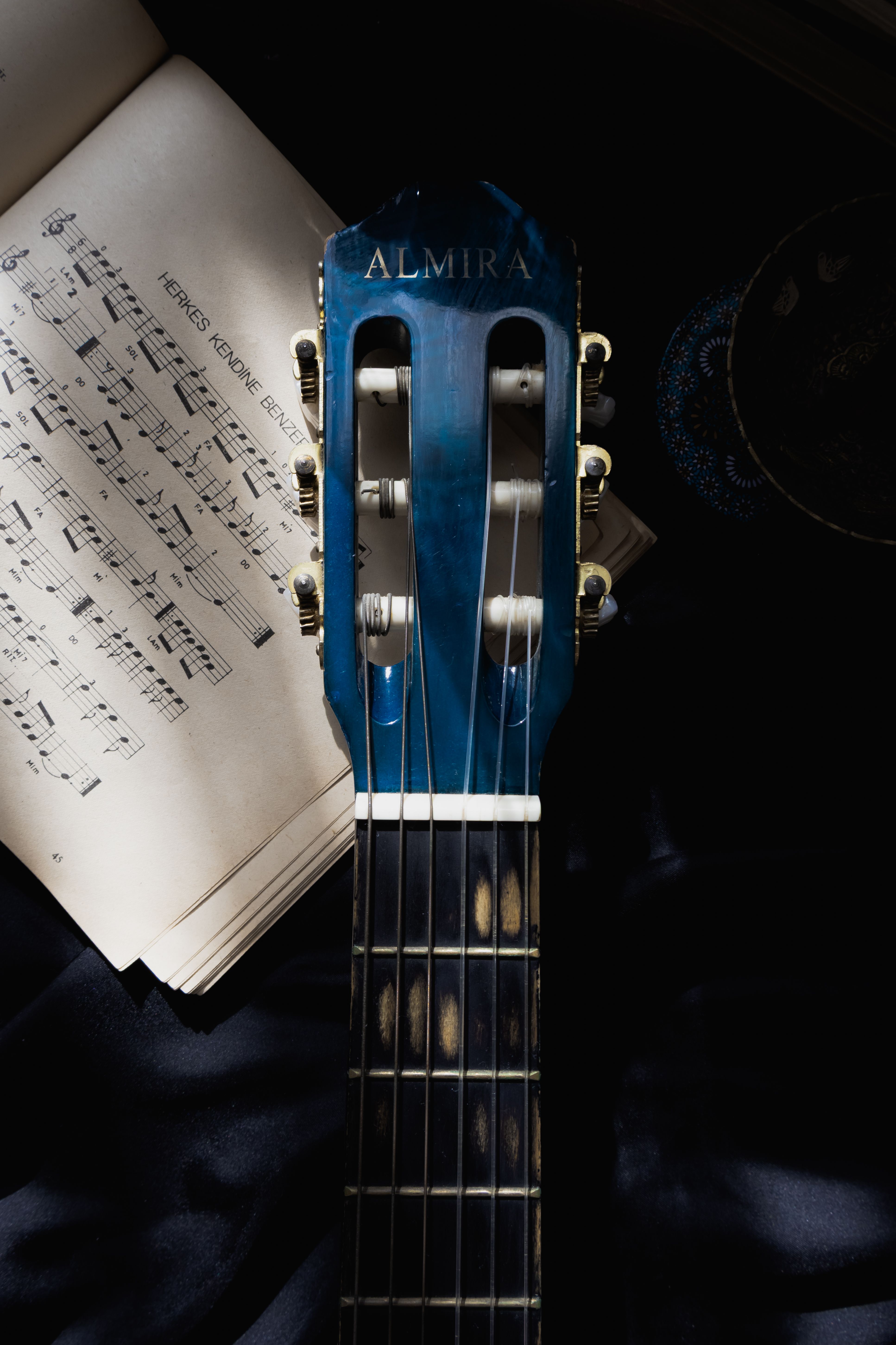 Close-Up of Guitar Neck with Sheet Music · Free Stock Photo