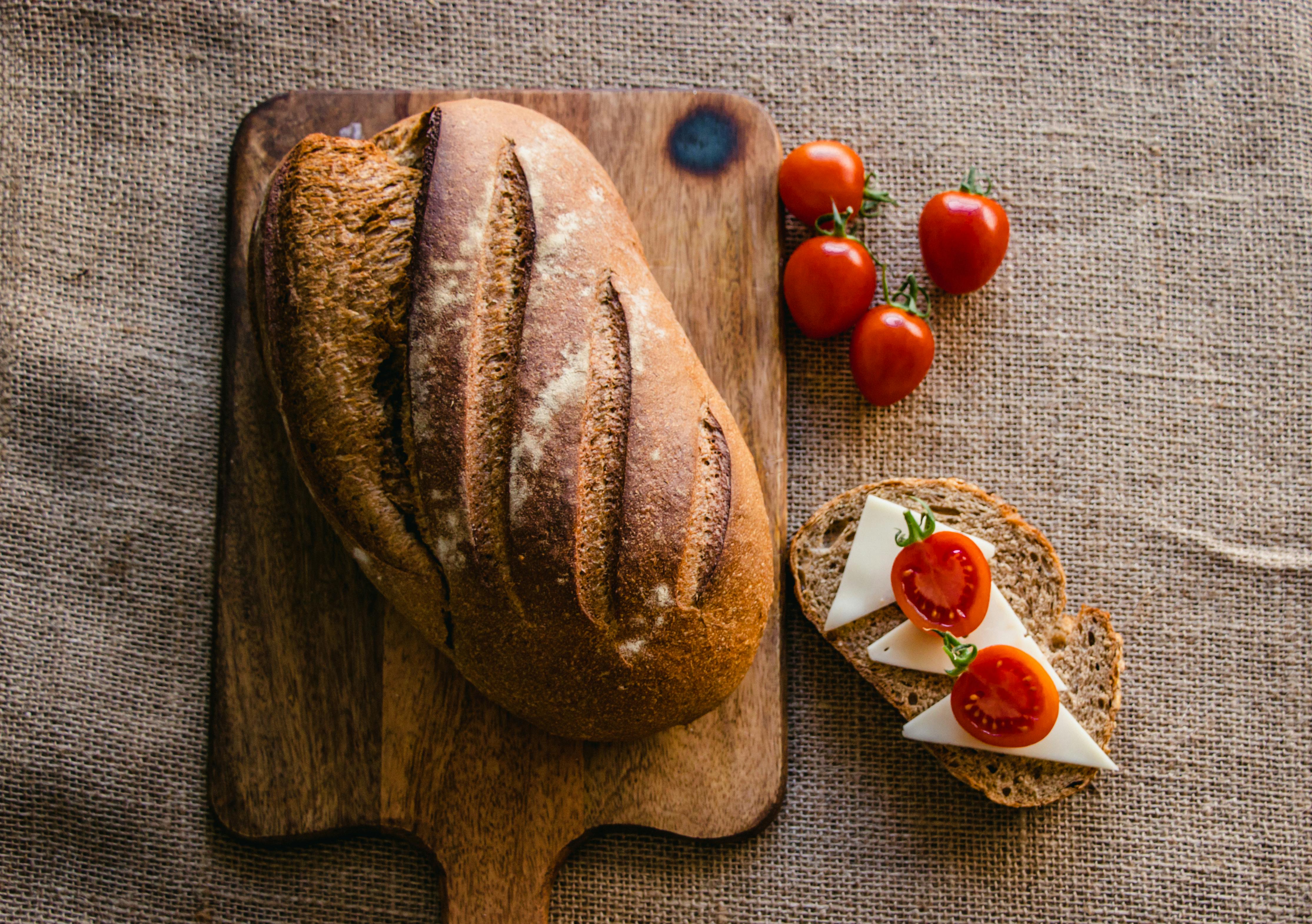 Rustic Artisan Bread with Cheese and Tomatoes · Free Stock Photo