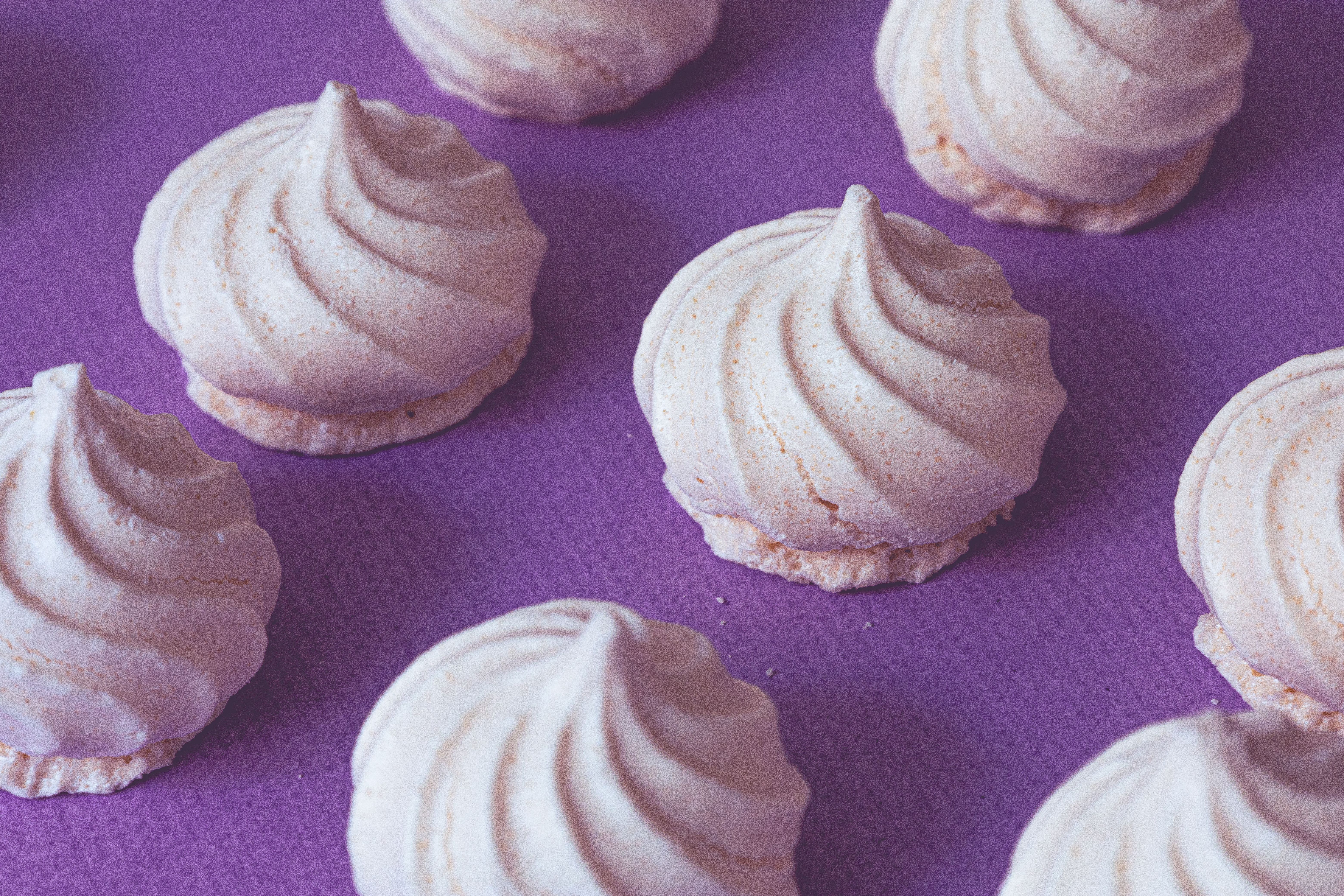 Elegant Meringue Cookies on Purple Background · Free Stock Photo