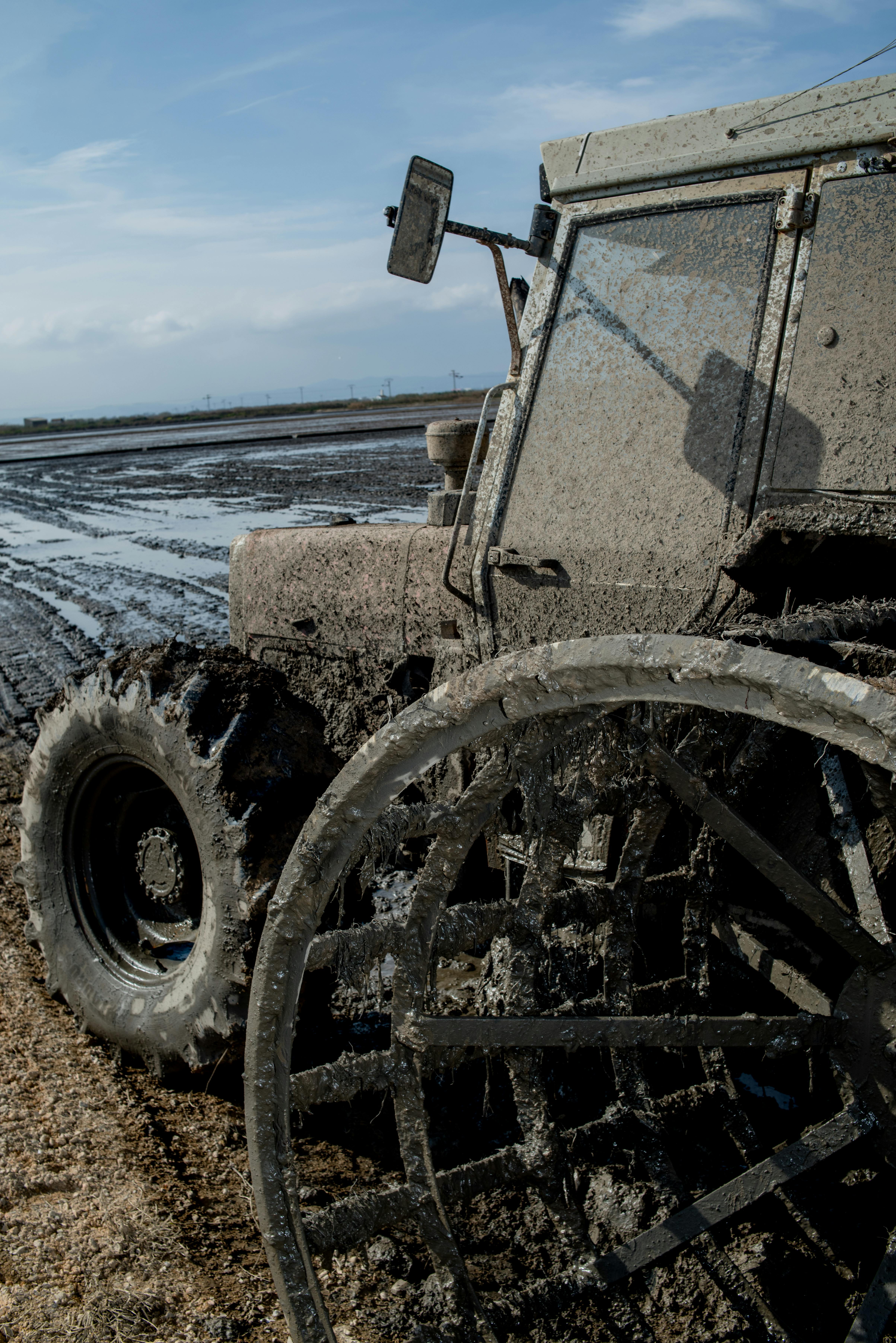 Muddy Tractor in Field on a Cloudy Day · Free Stock Photo