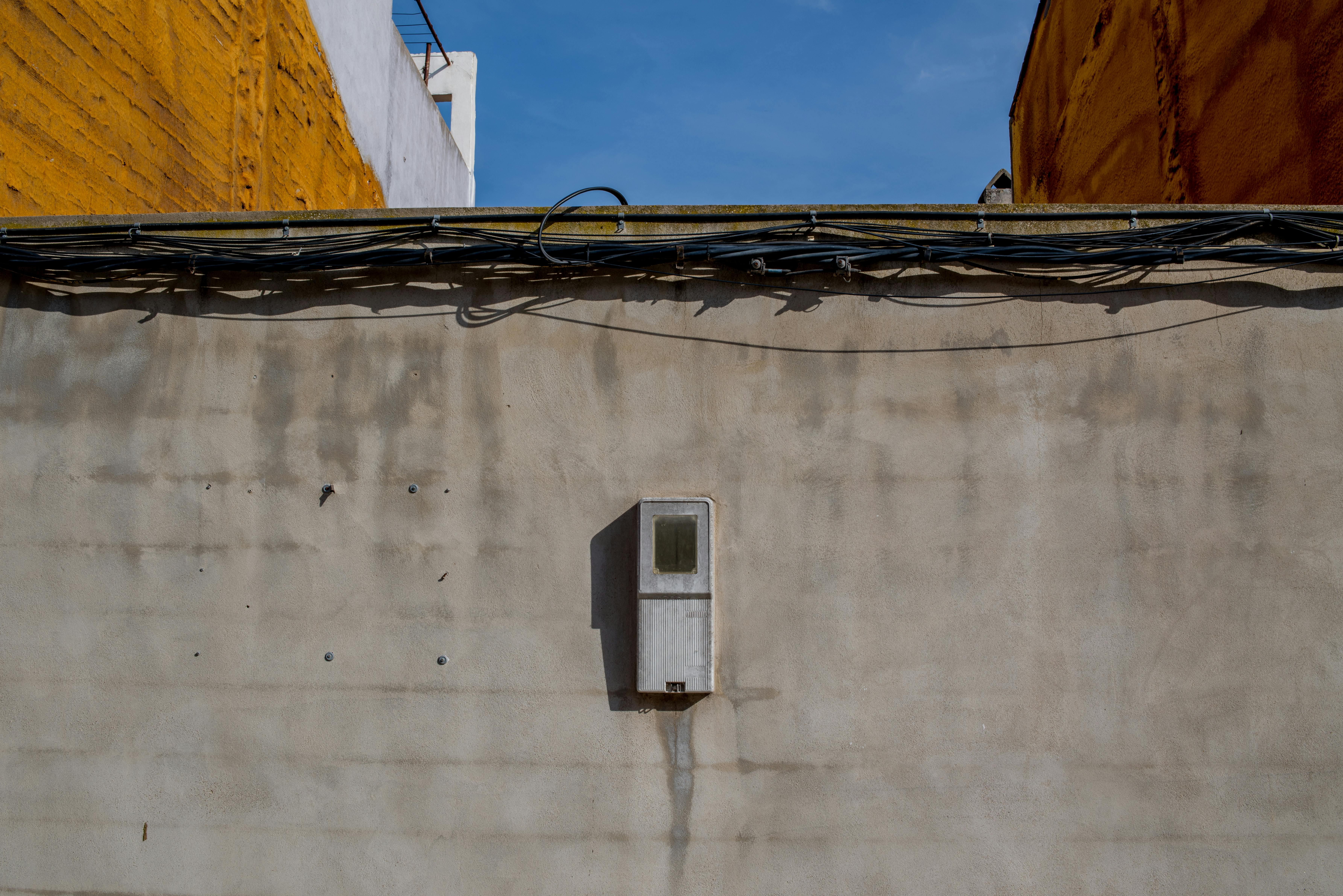 Urban Wall with Abstract Shadows and Electrical Box · Free Stock Photo