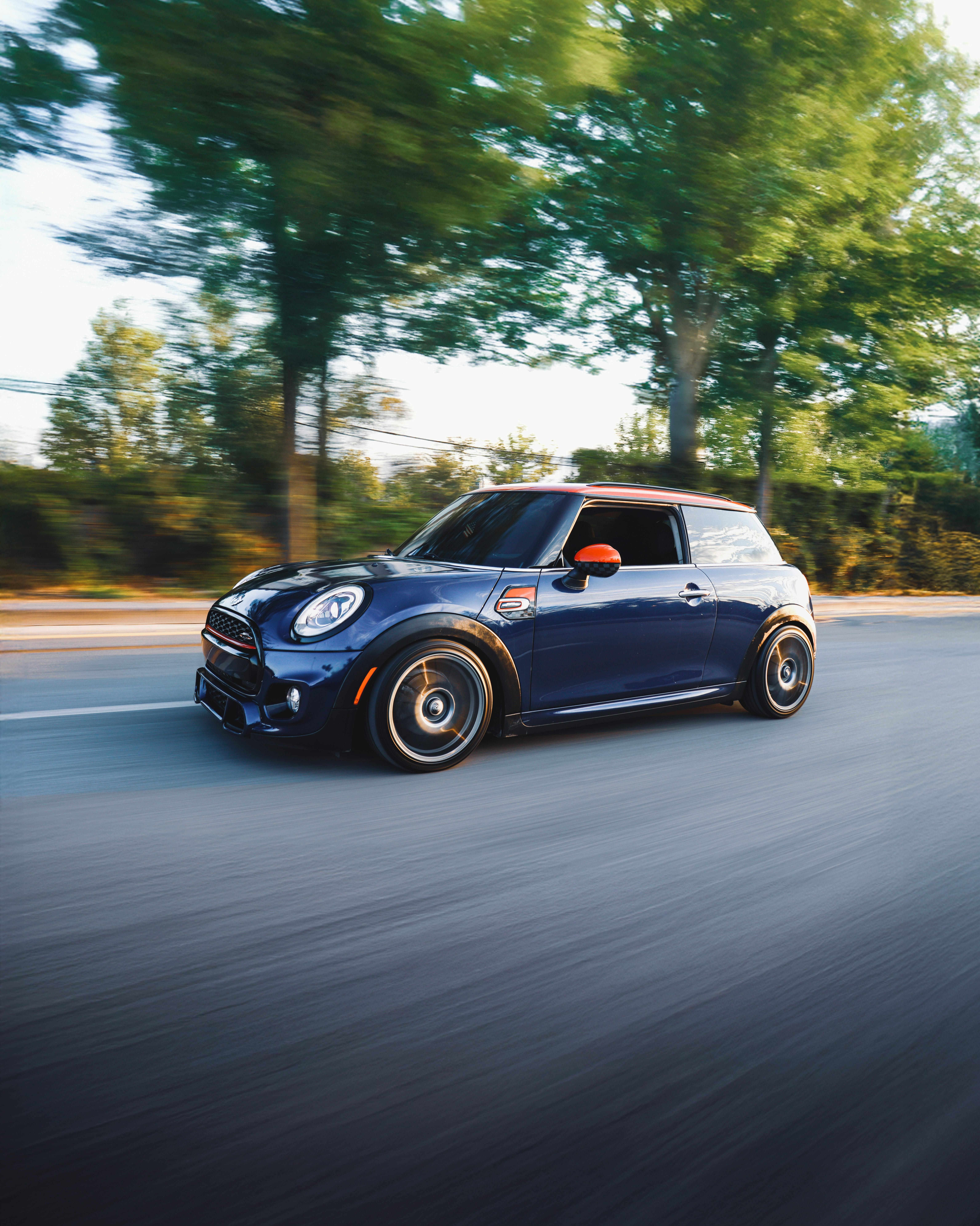 Dynamic Shot of a Classic Mini Cooper on Road · Free Stock Photo