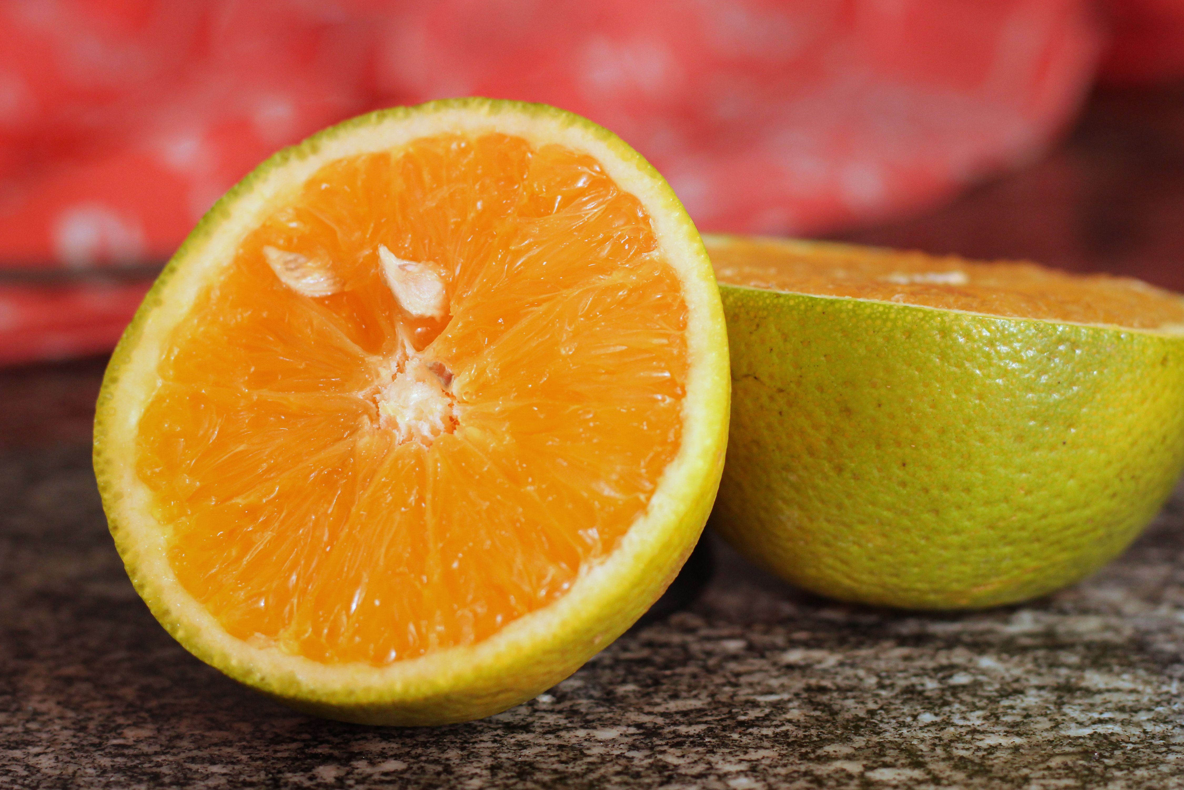 Close-up of Freshly Sliced Orange on Granite Surface · Free Stock Photo