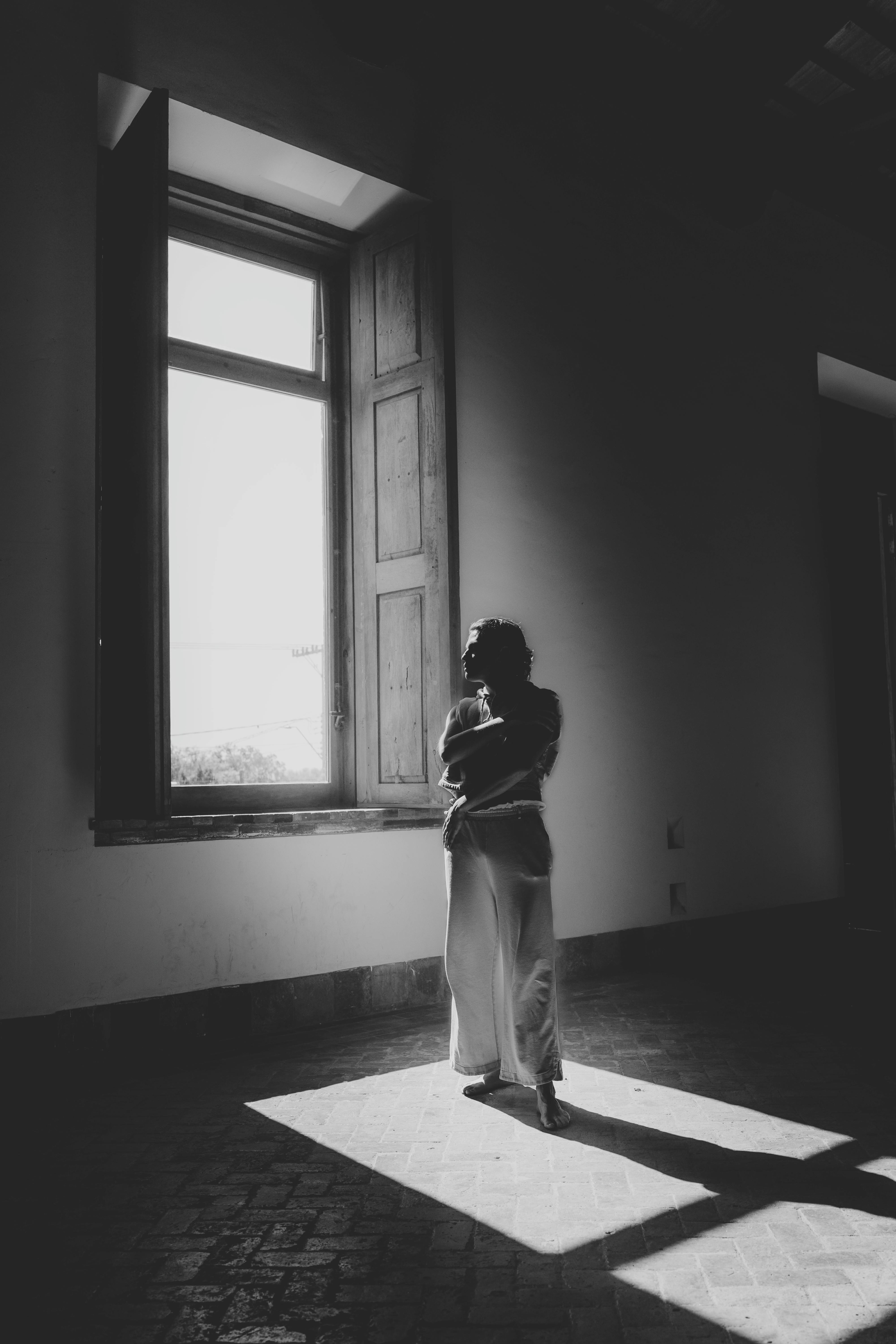 Elegant Woman Posing in Black and White Shadowed Room · Free Stock Photo