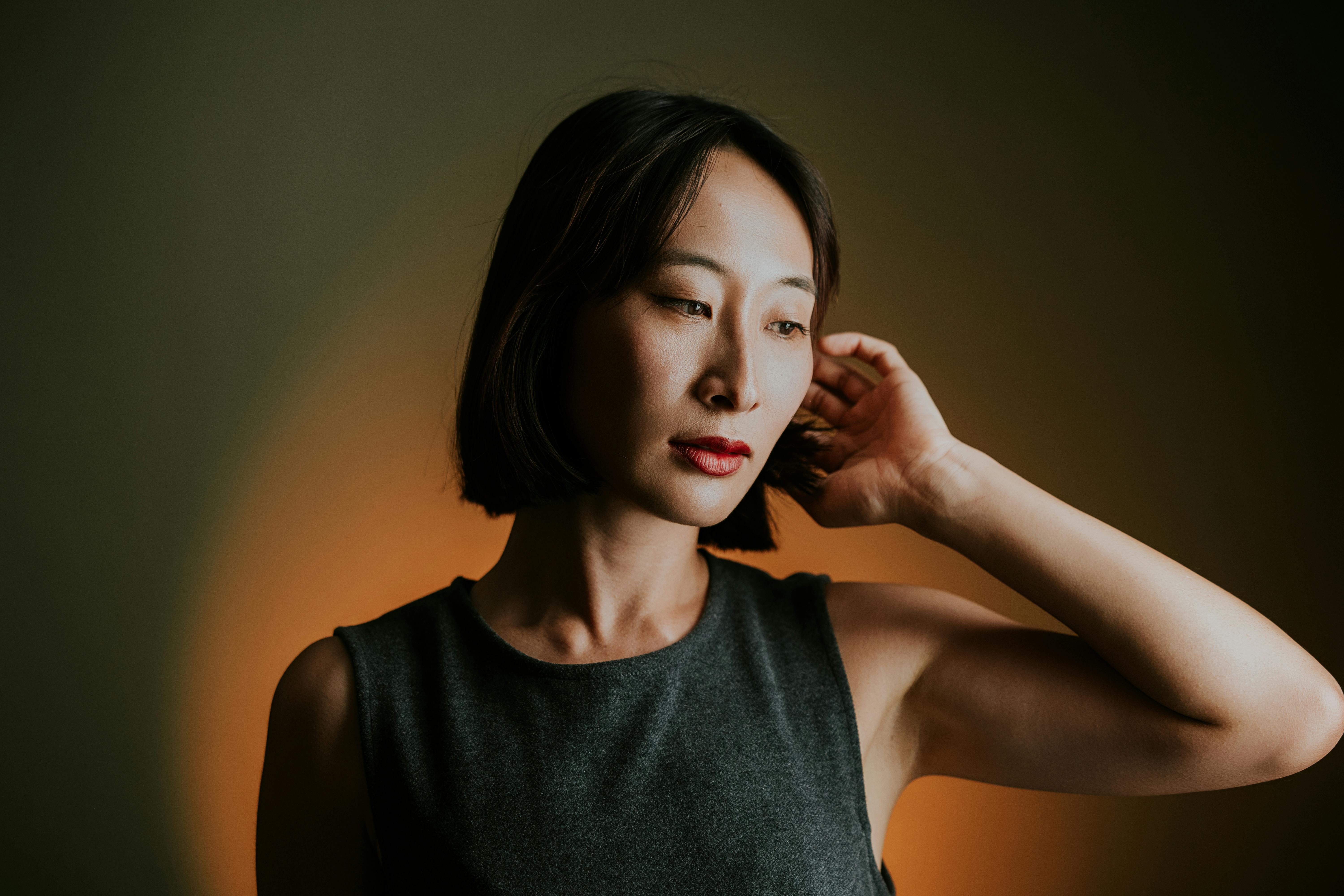 Portrait of a Thoughtful Woman with Dramatic Lighting · Free Stock Photo