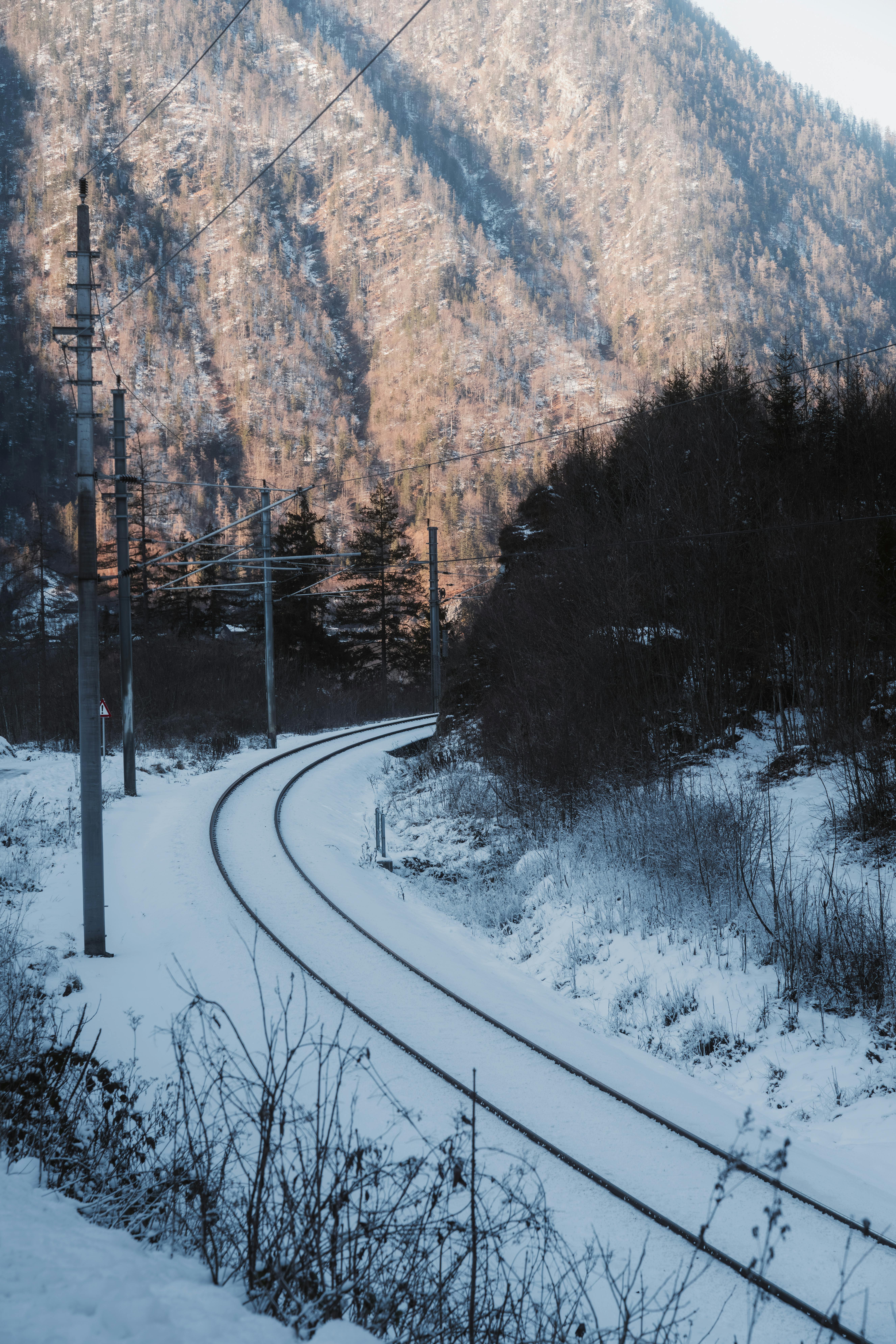Scenic Winter Railroad Through Snowy Mountains · Free Stock Photo