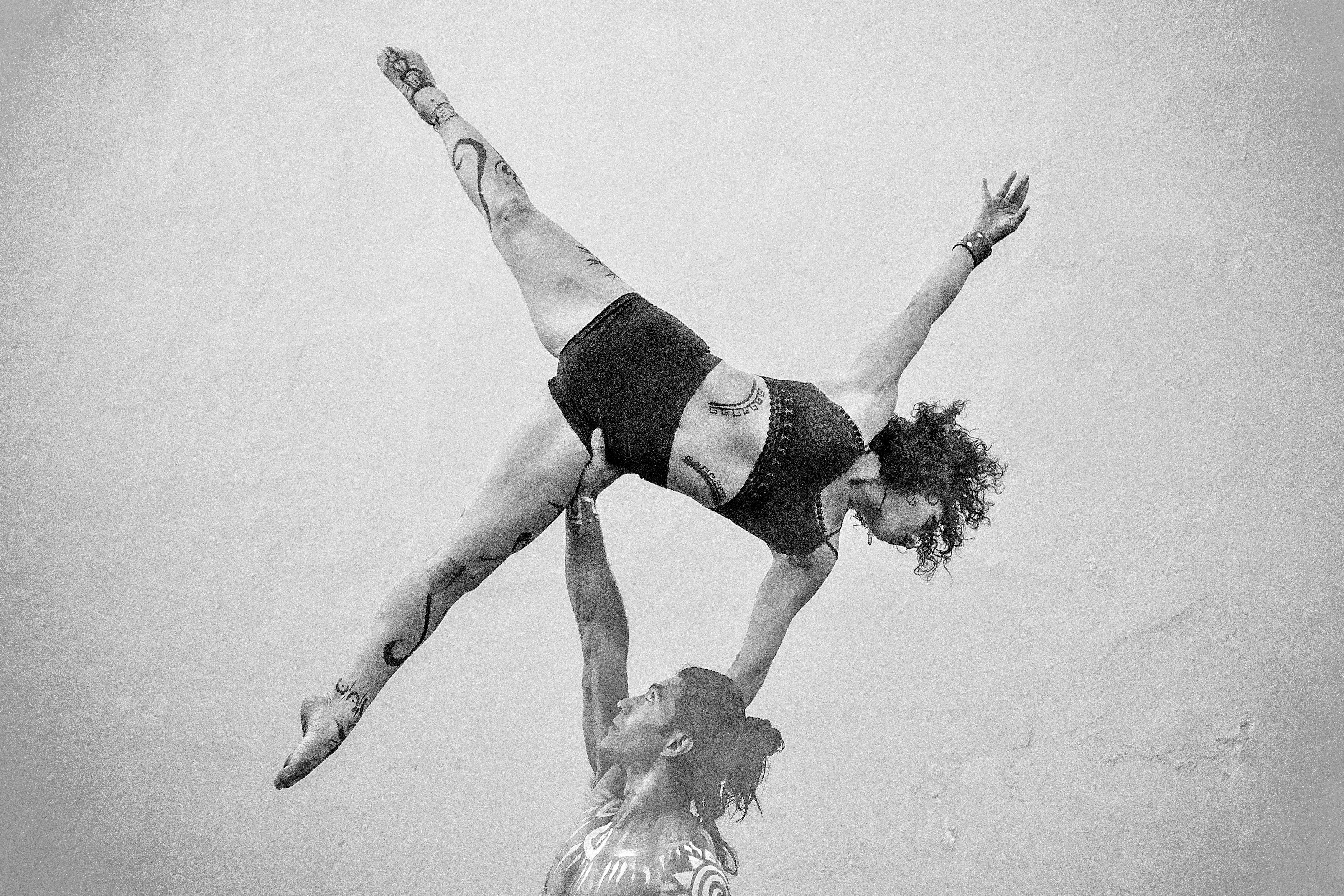 Dynamic Acrobatic Balance in Black and White · Free Stock Photo