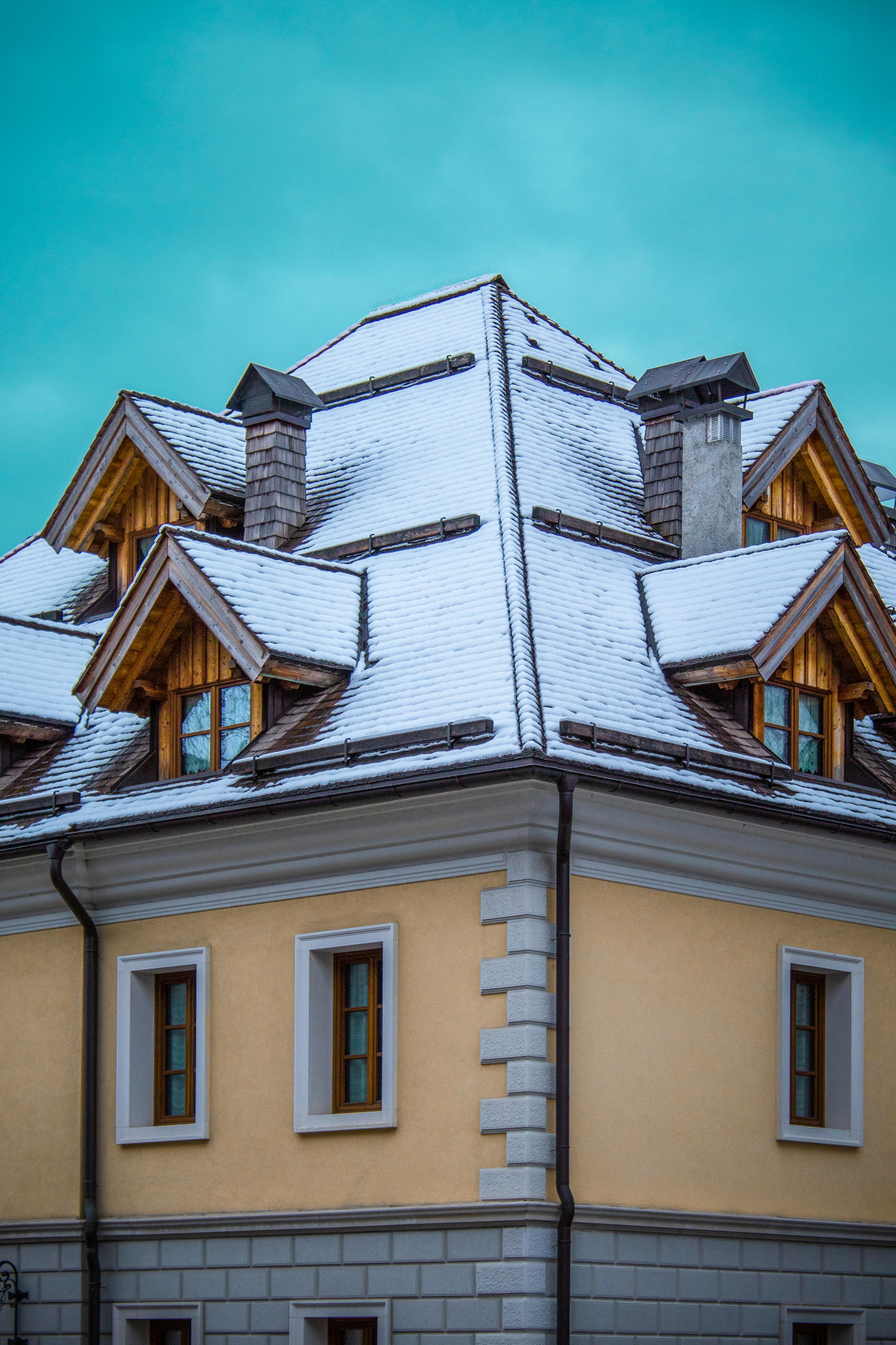 Charming Alpine House with Snowy Roof in Tarvisio · Free Stock Photo