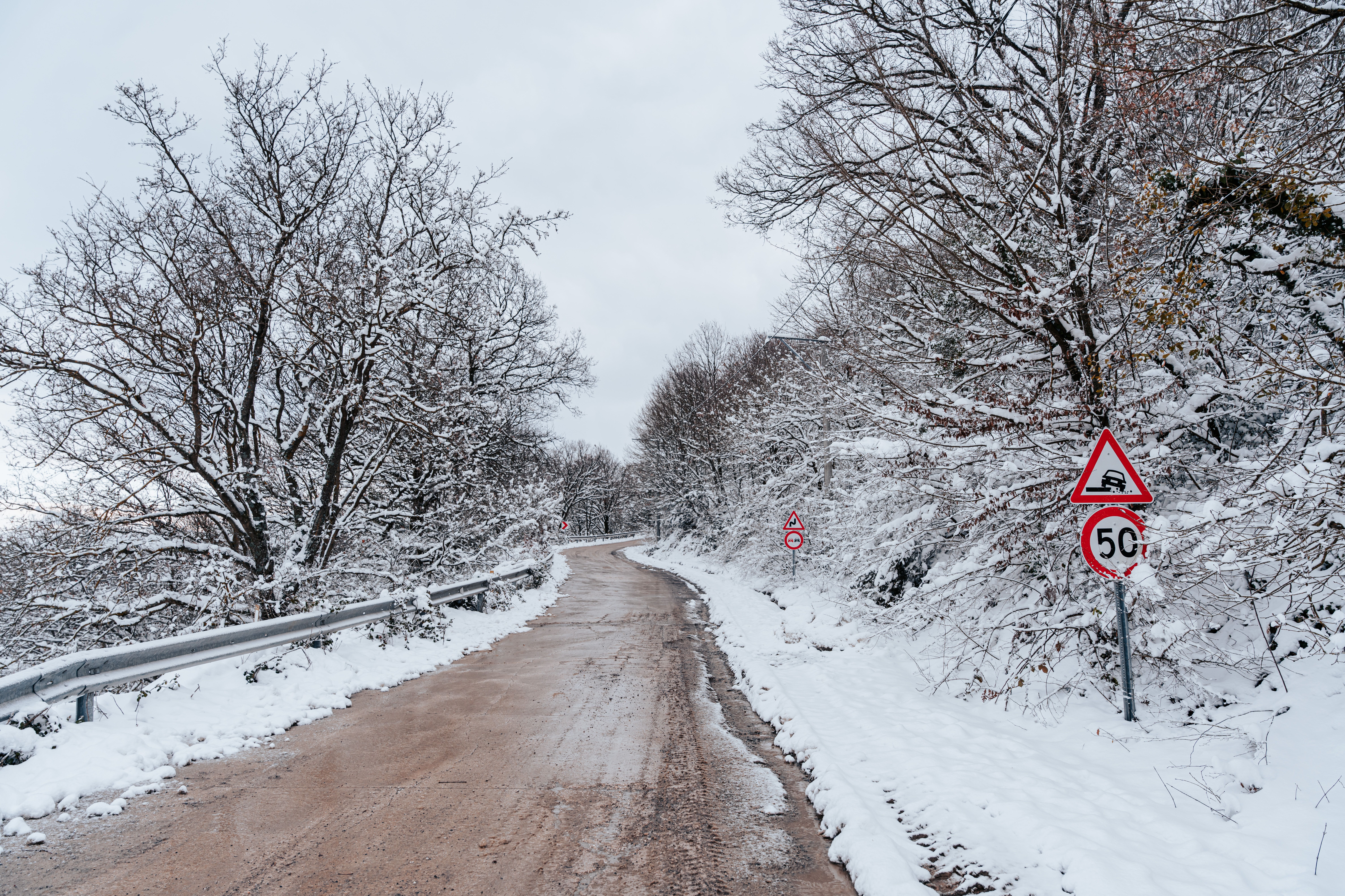 Snowy Winter Road with Caution Sign · Free Stock Photo