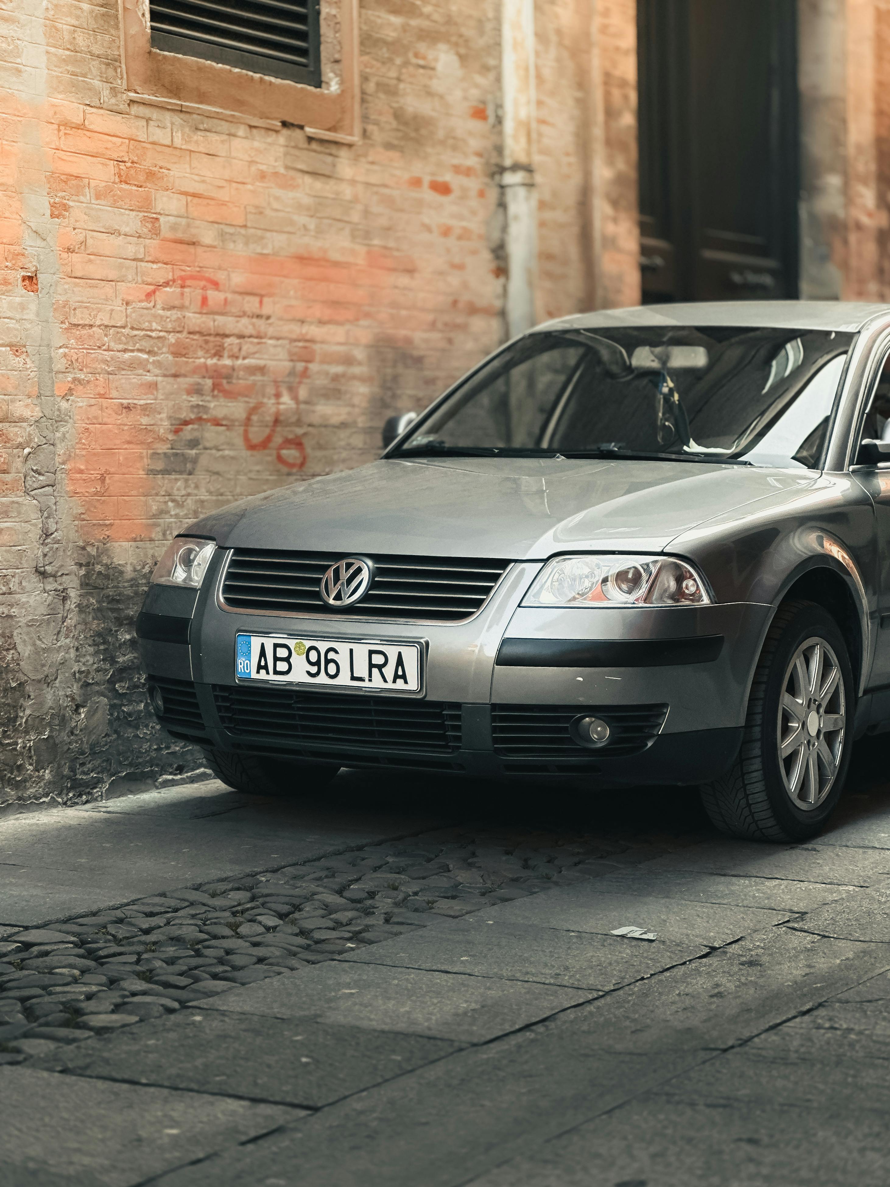 Parked Grey Sedan in Urban Alleyway · Free Stock Photo