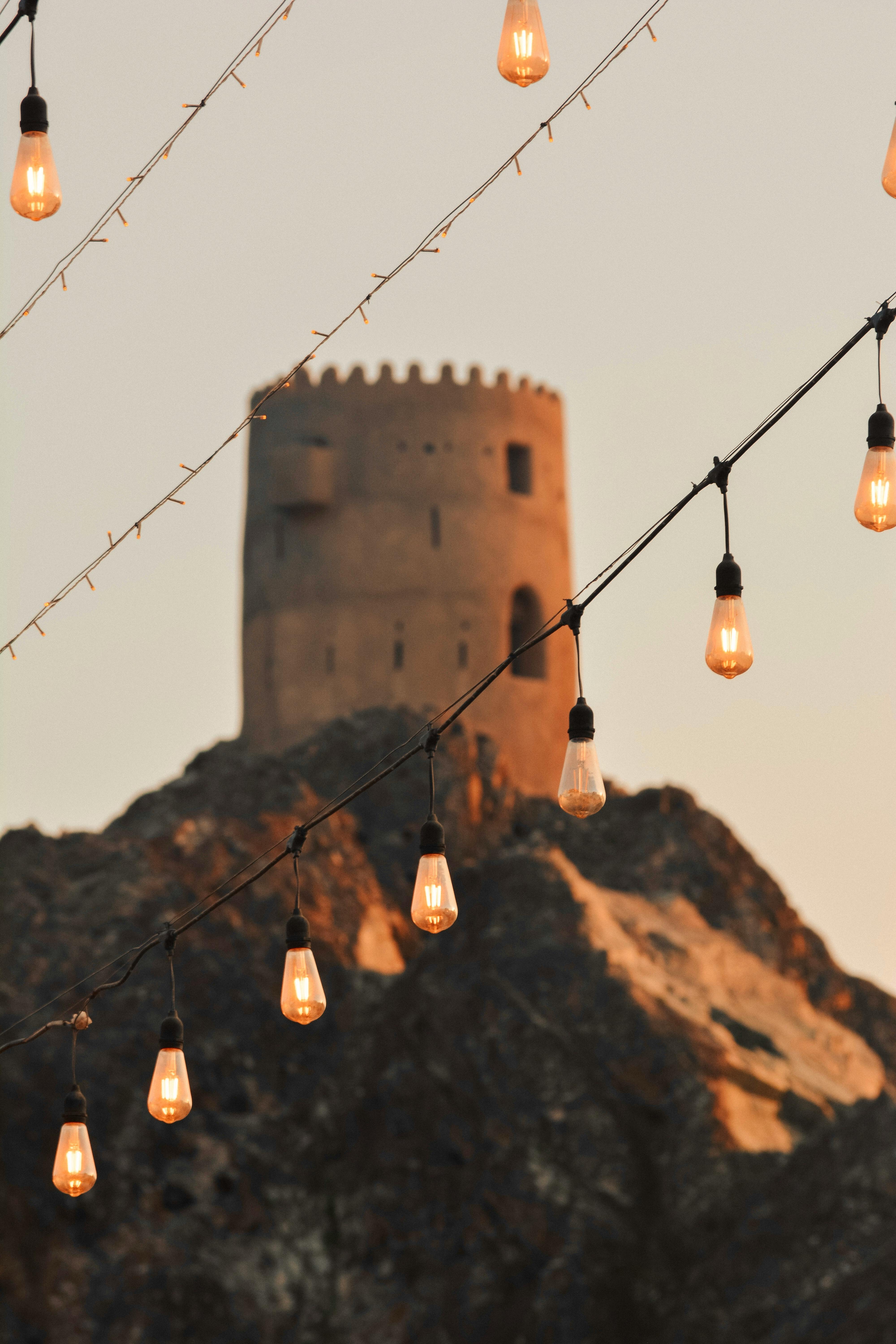Rustic Tower at Twilight in Muscat with Lights · Free Stock Photo