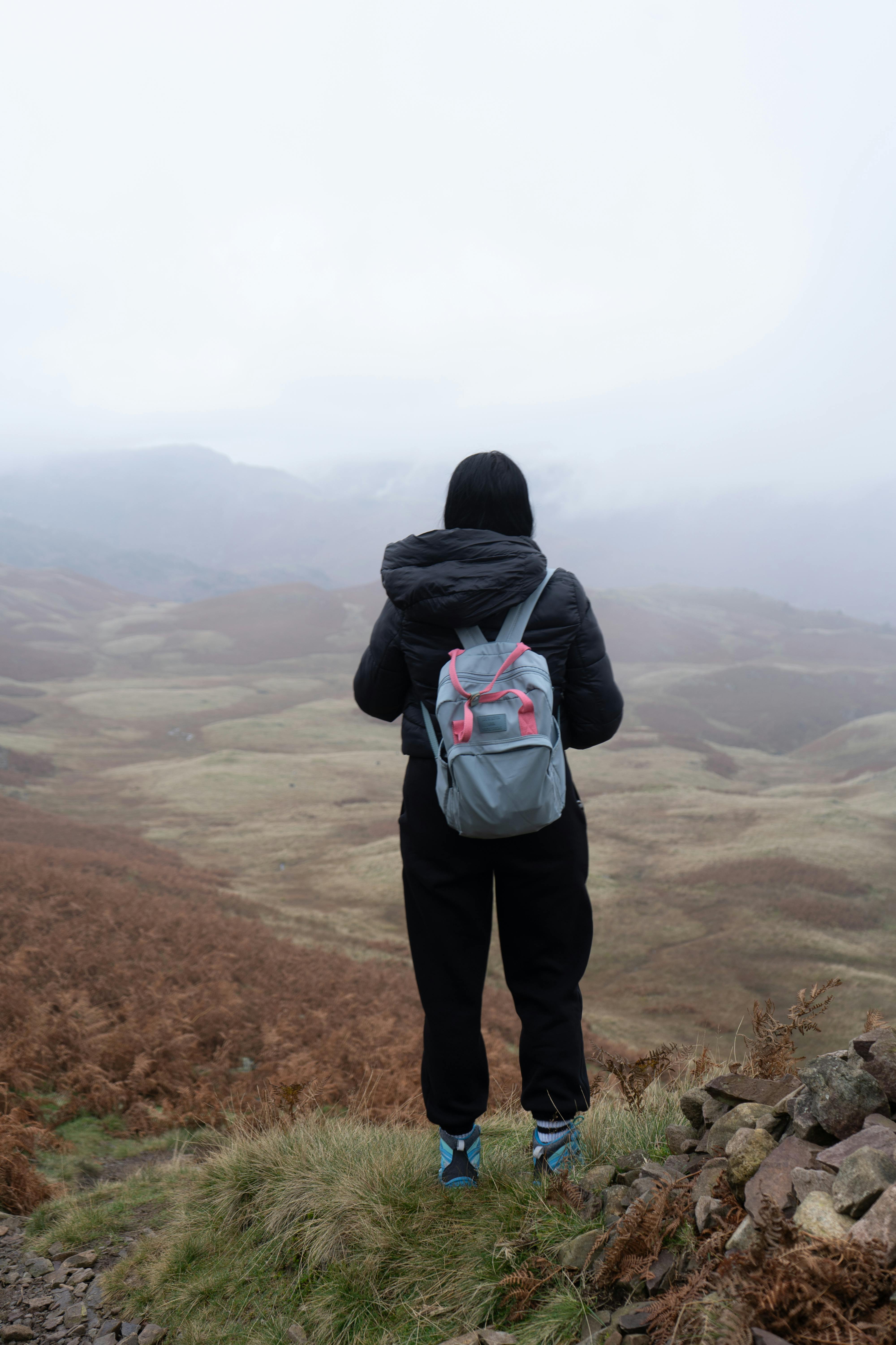 Hiker Overlooking Misty Mountain Landscape · Free Stock Photo