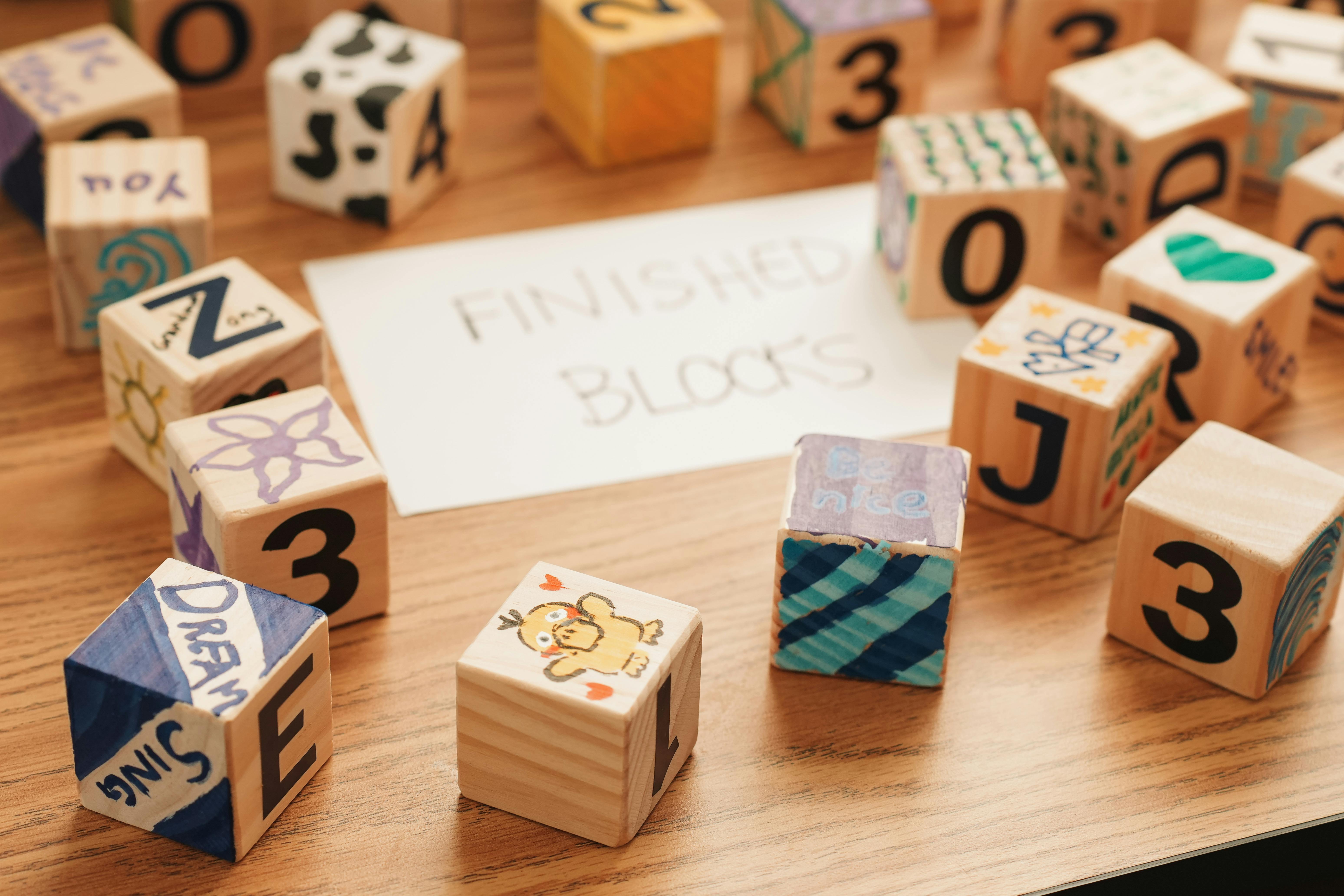 Colorful Alphabet and Number Blocks on Table · Free Stock Photo