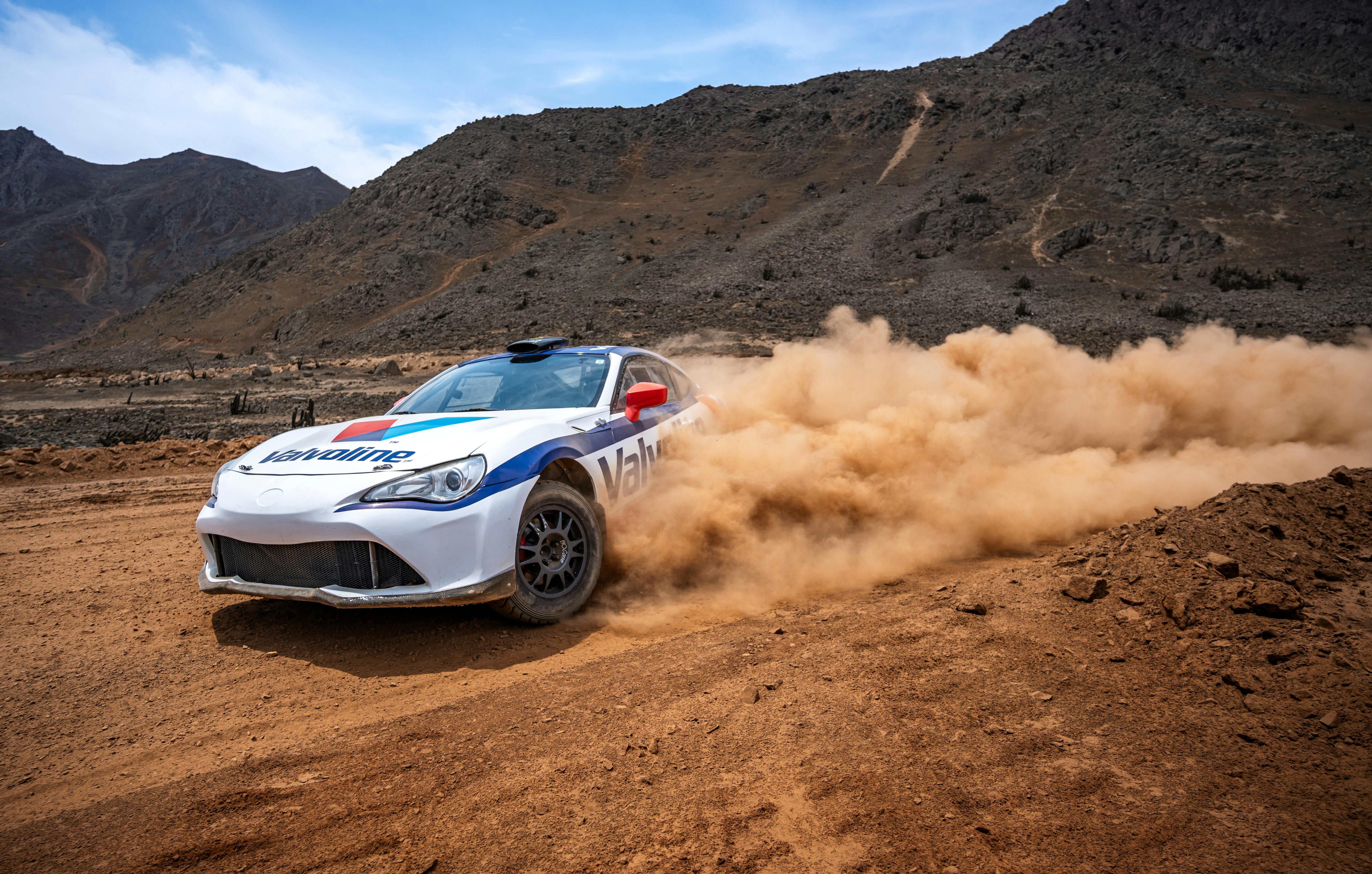 Rally Car Drifting on Mountainous Dirt Track · Free Stock Photo