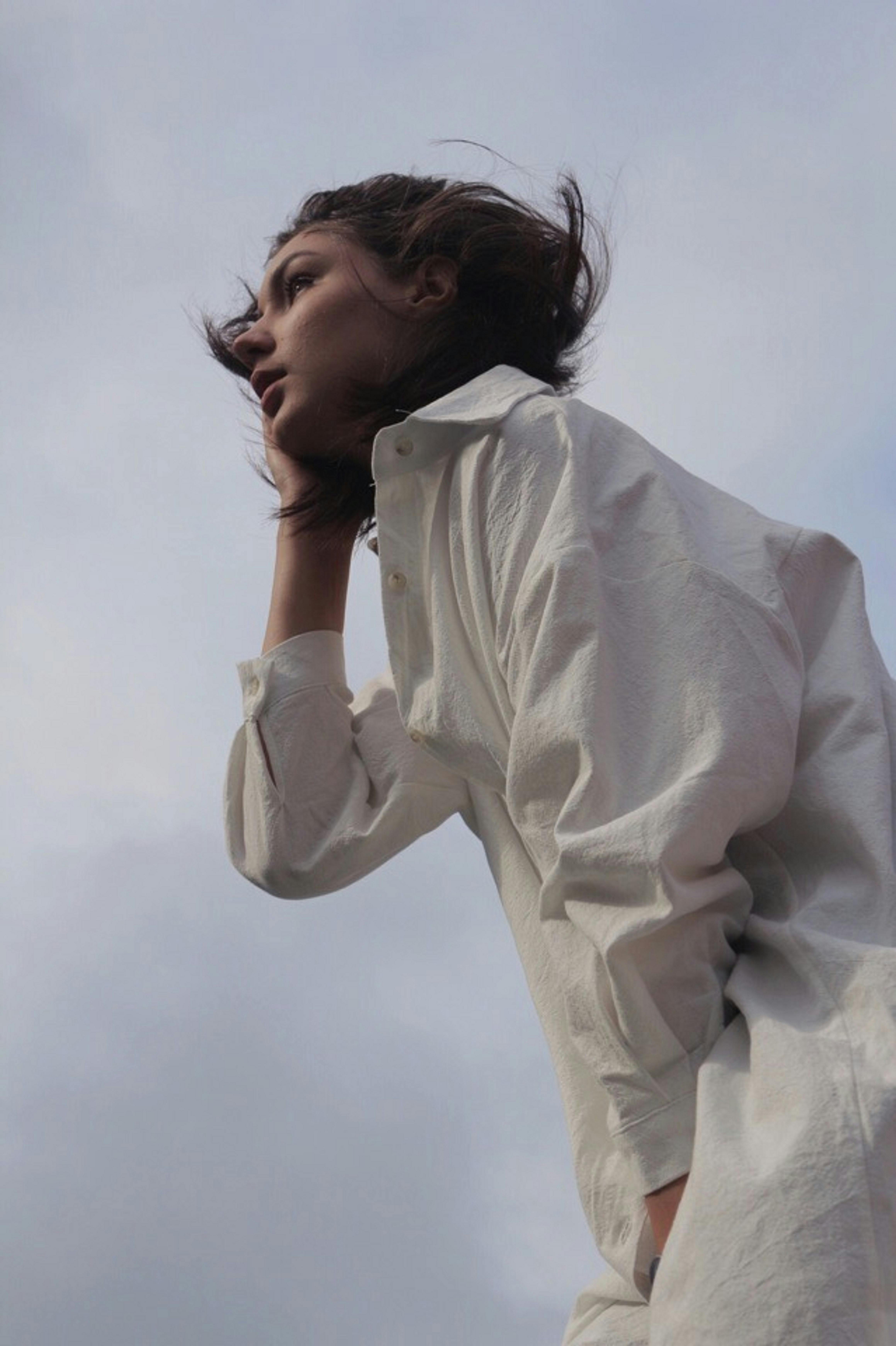 Low Angle Photo of Woman in Yellow Crop Top Posing While Looking Down ...