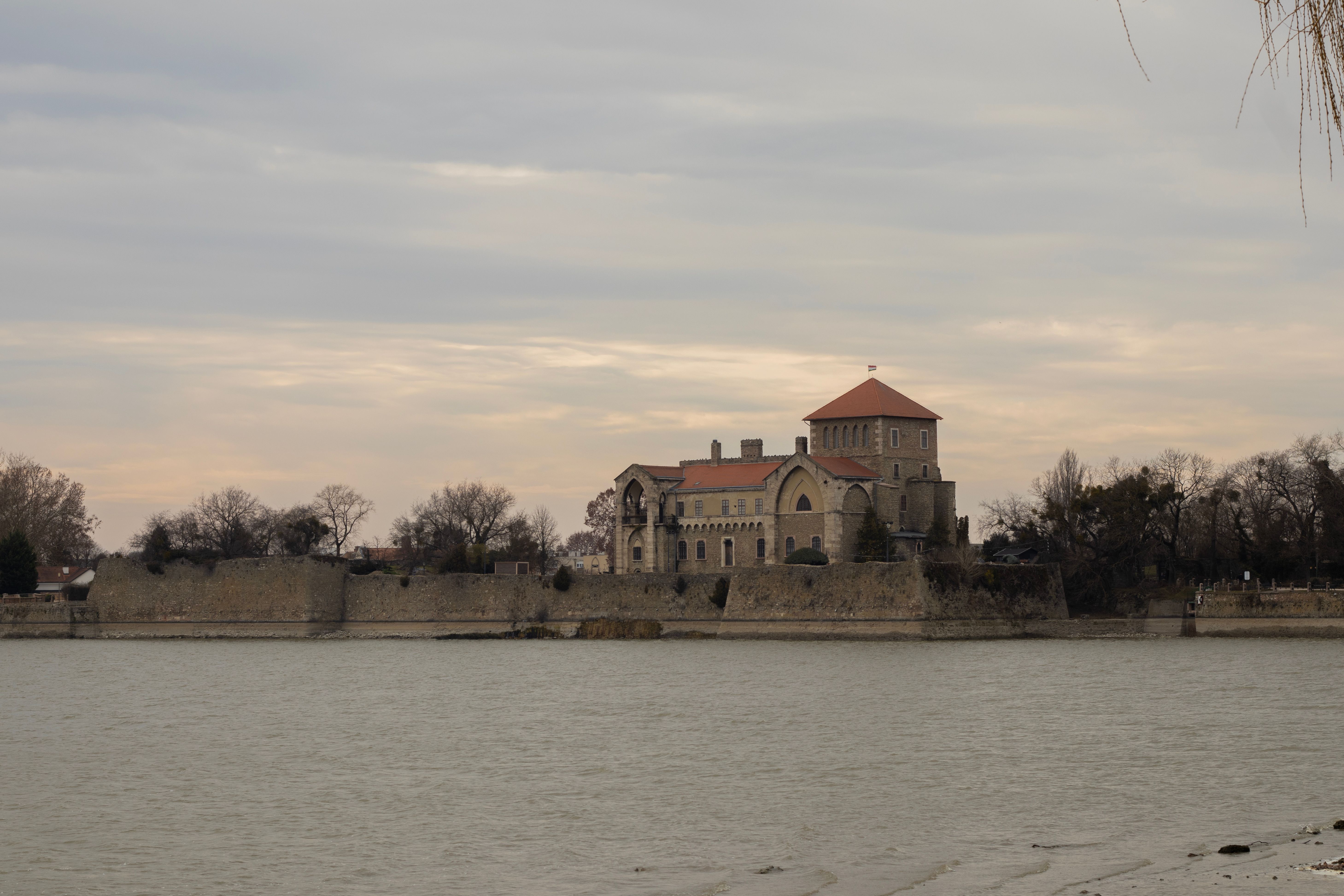 Historic Castle on Tranquil Riverside in Winter · Free Stock Photo