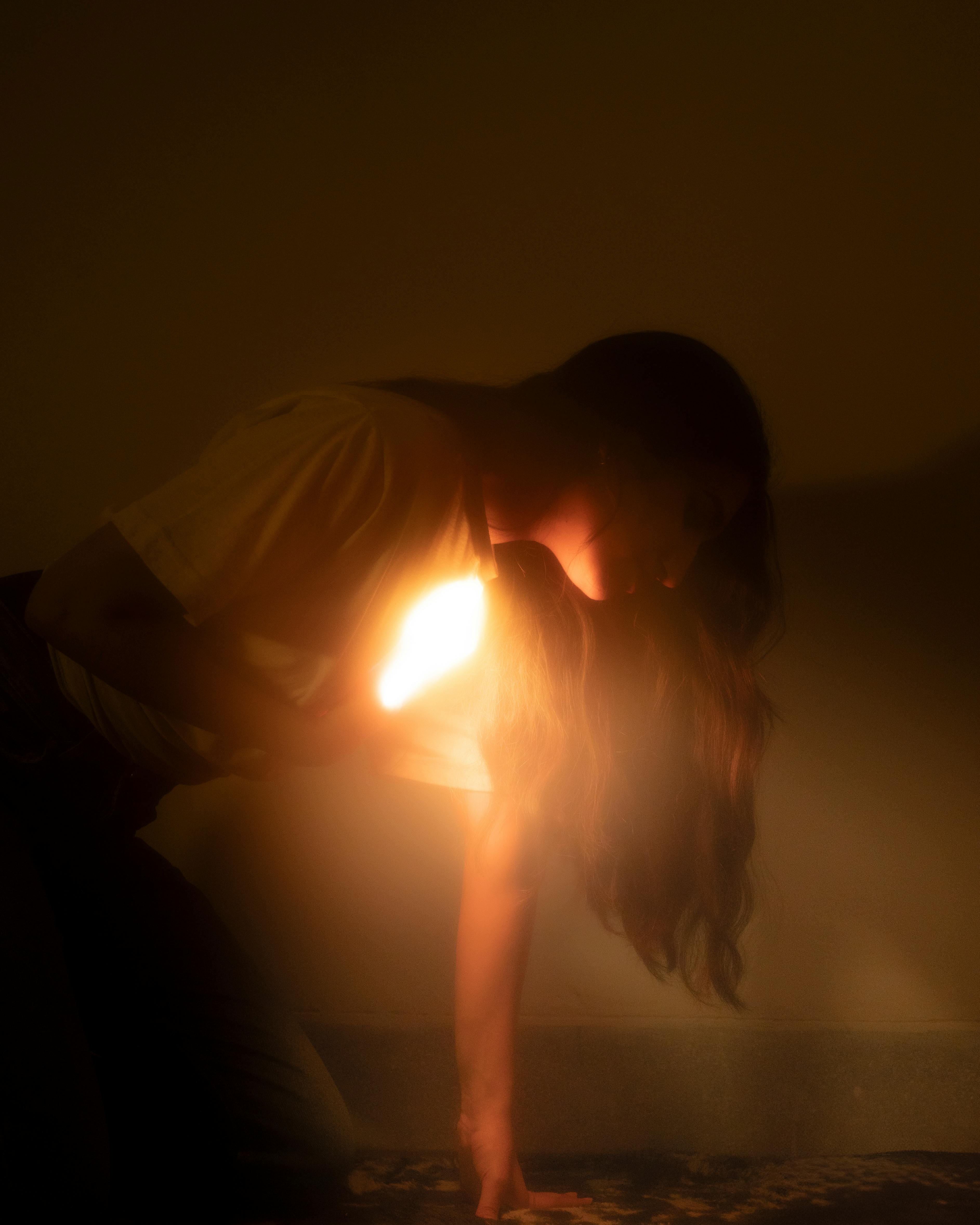 Mystical Light Emanating from Woman in Darkness · Free Stock Photo