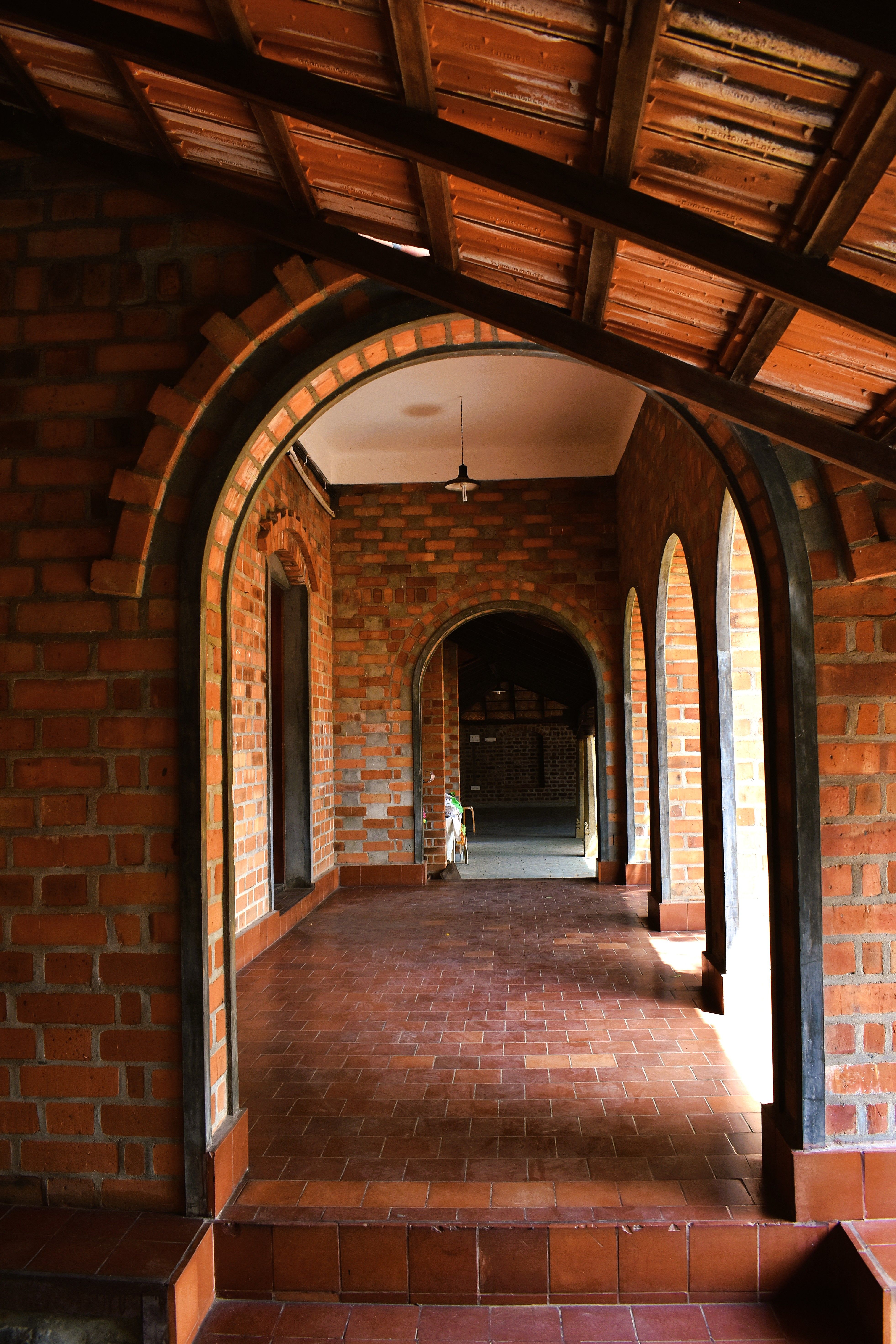 Rustic Arched Brick Corridor in Sunlight · Free Stock Photo