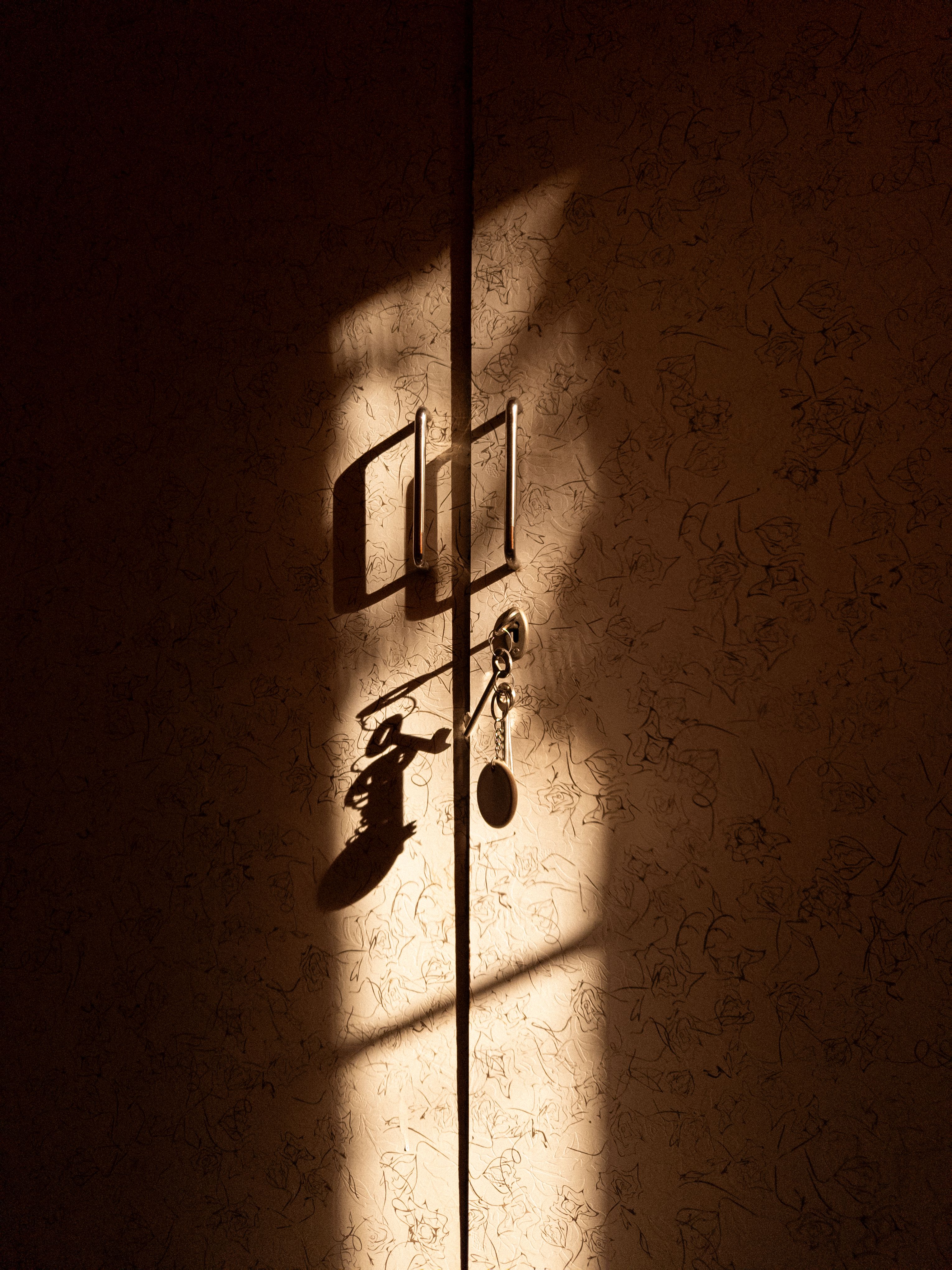 Shadow of Key on Textured Wall · Free Stock Photo