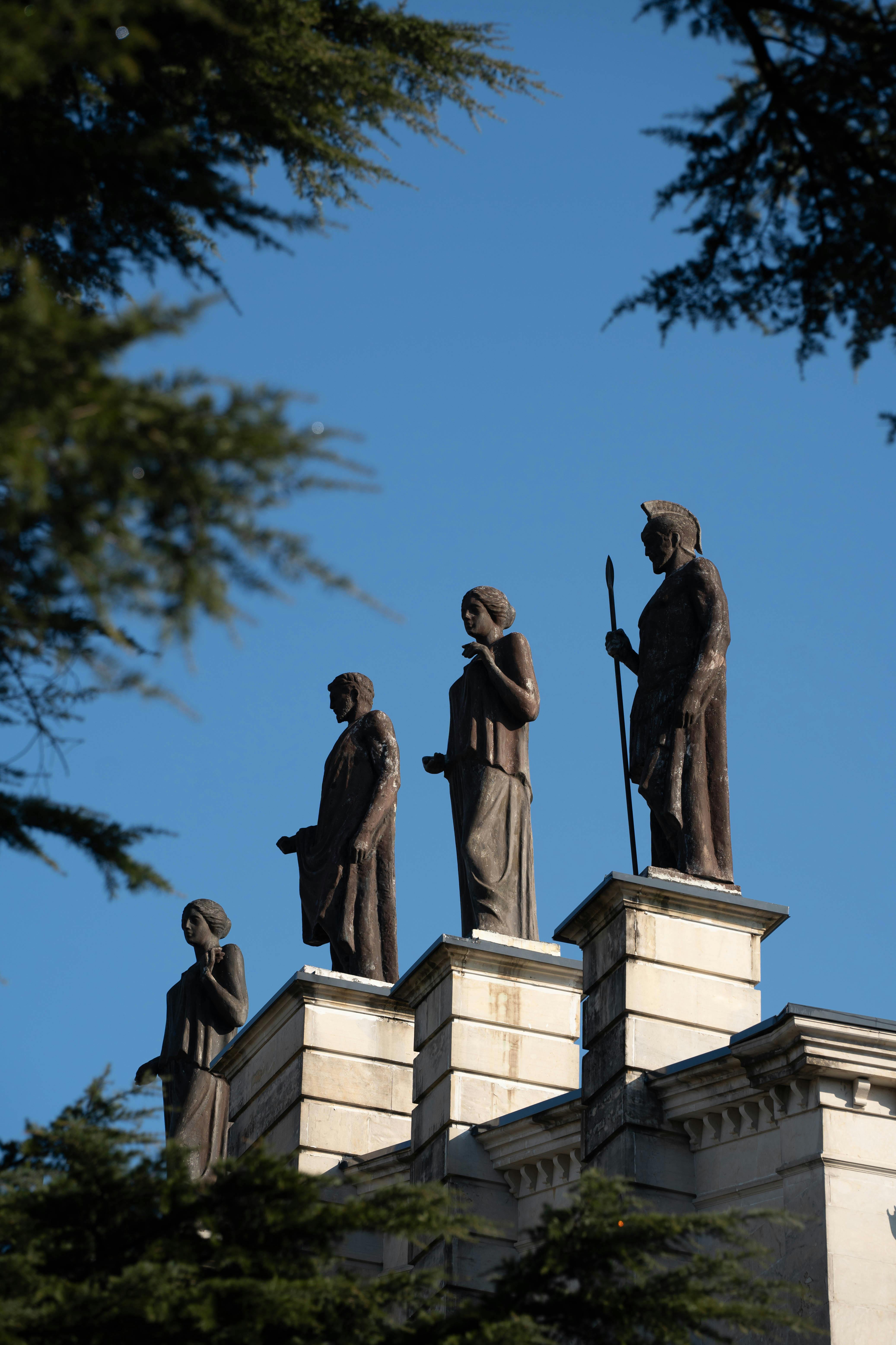 Historic Statues on Building Rooftop · Free Stock Photo