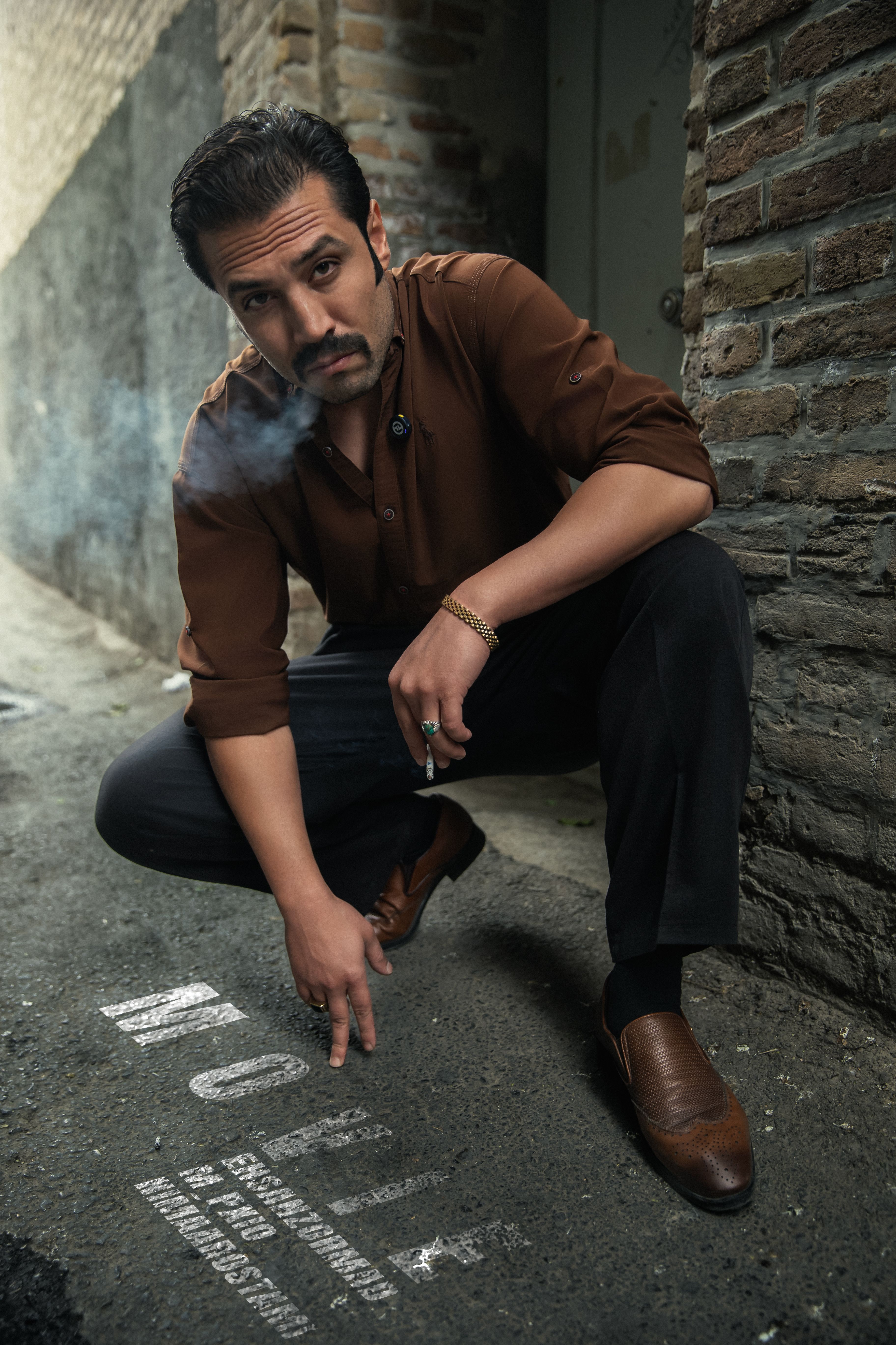 Man Squatting in Alley Smoking a Cigarette · Free Stock Photo