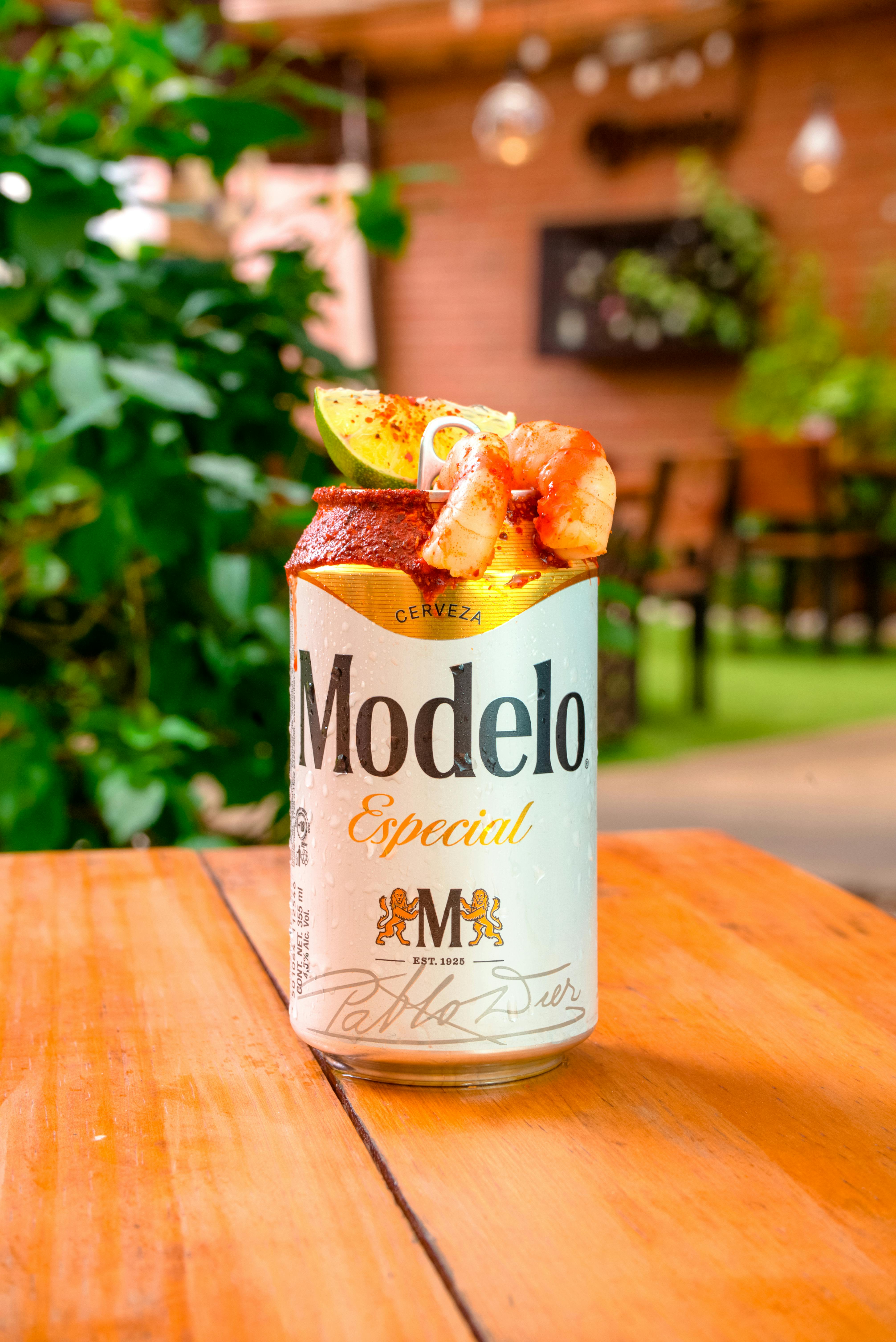 Modelo Especial Beer with Fruit Garnish on Table · Free Stock Photo