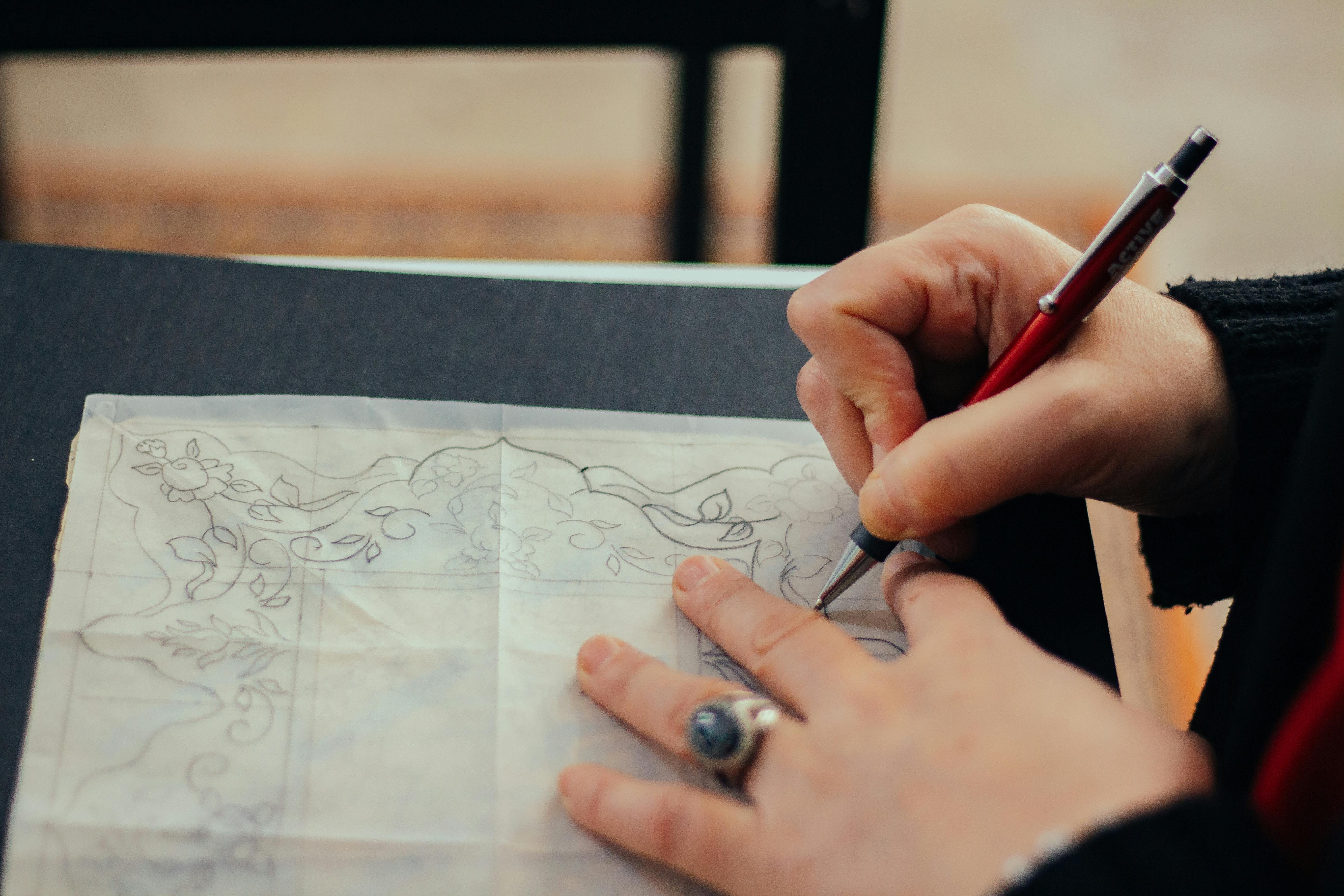 Close-Up of Artistic Floral Sketching on Tracing Paper · Free Stock Photo