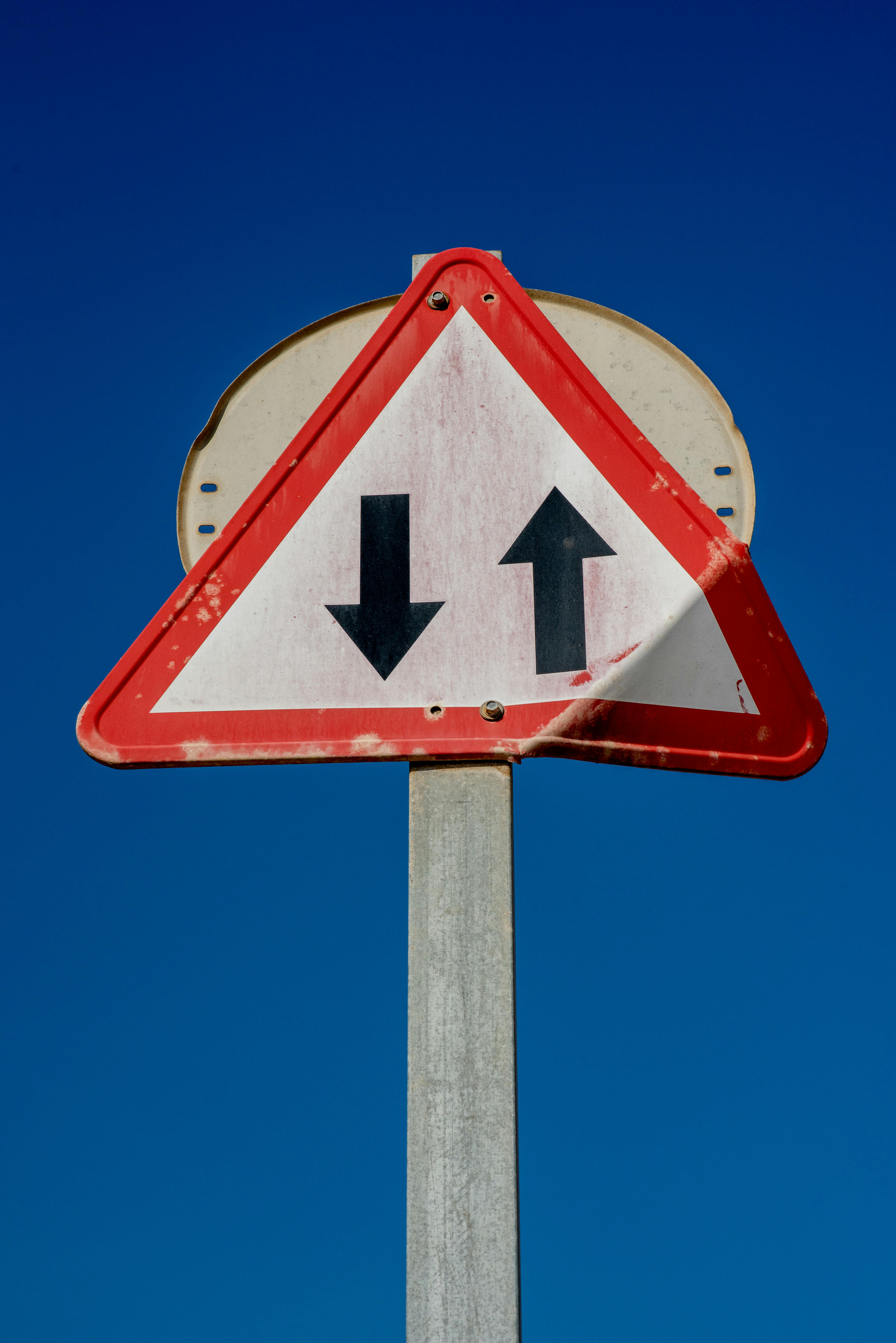 Traffic Sign with Two-Way Direction Arrows · Free Stock Photo