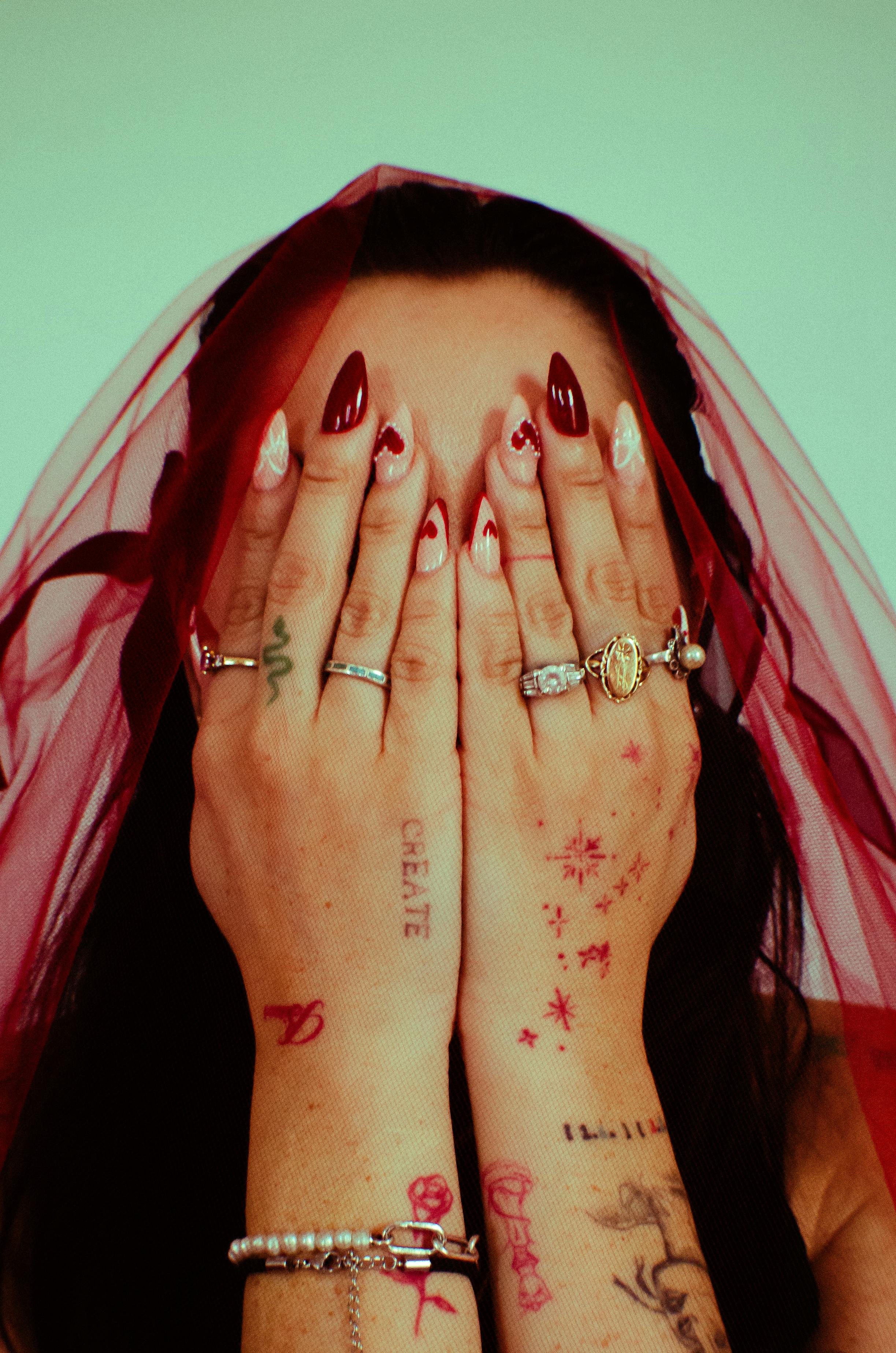Tattooed Hands with Red Veil and Jewelry · Free Stock Photo