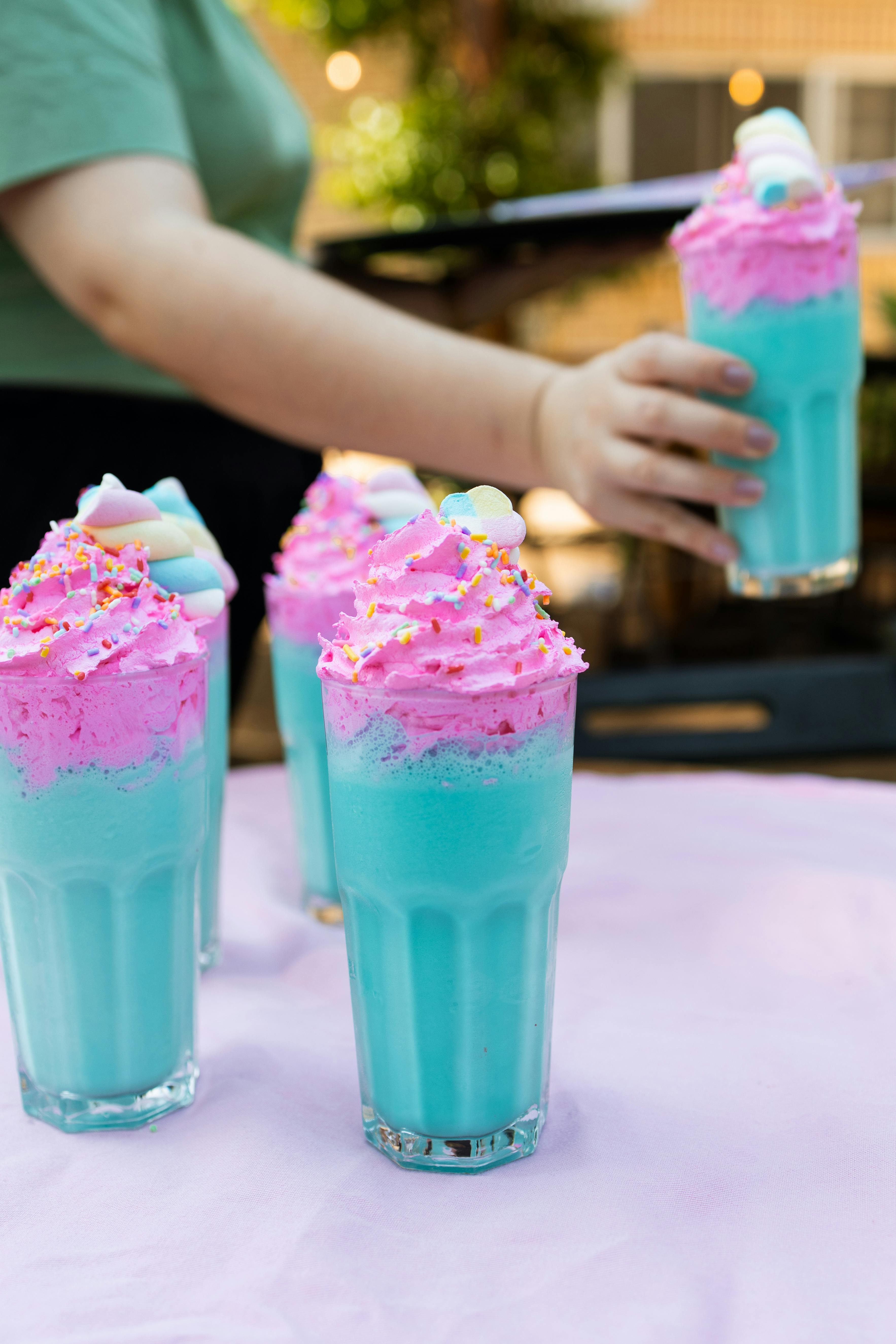 Colorful Milkshakes with Whipped Cream Outdoors · Free Stock Photo