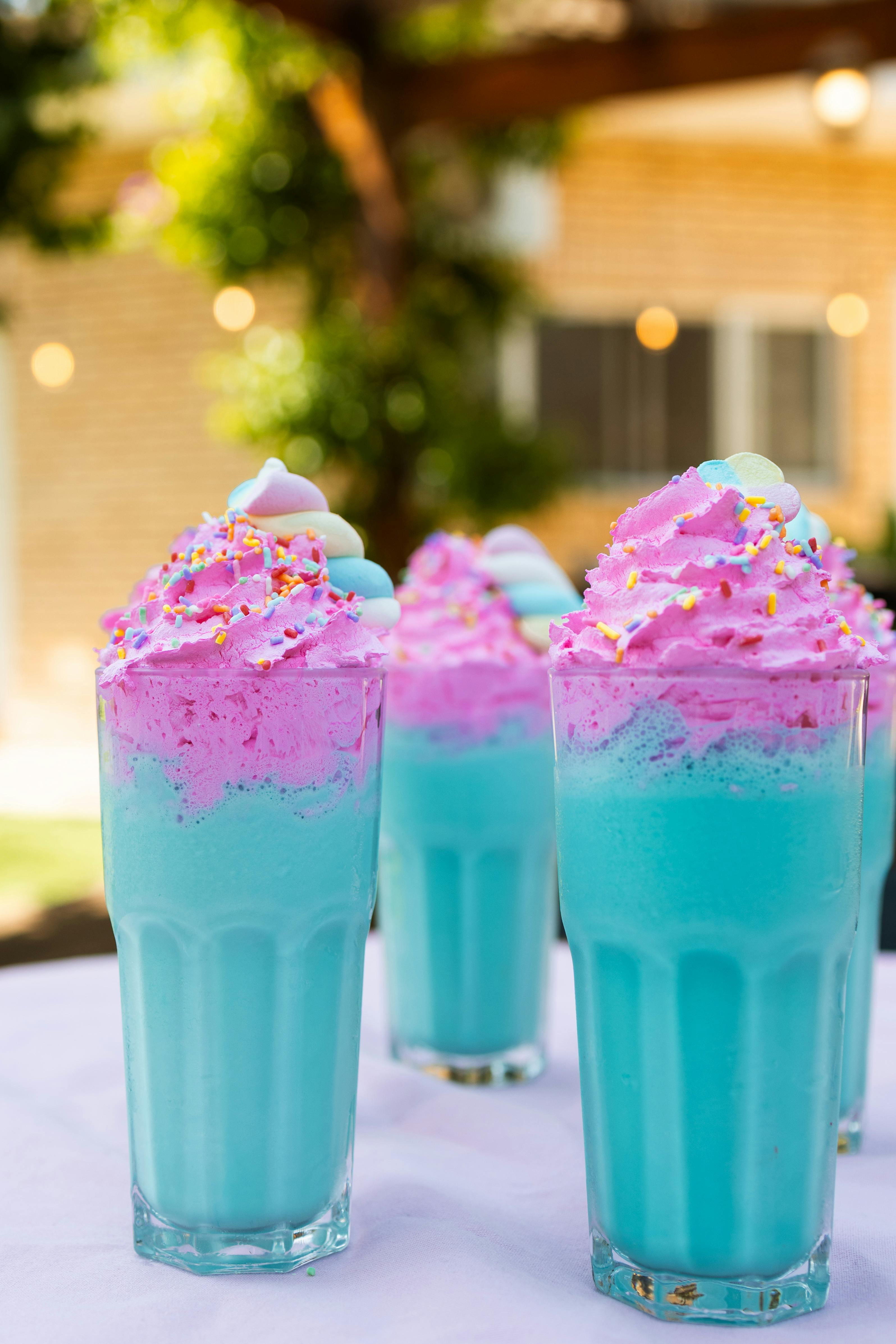 Vibrant Pink and Blue Milkshakes in Glasses Outdoors · Free Stock Photo