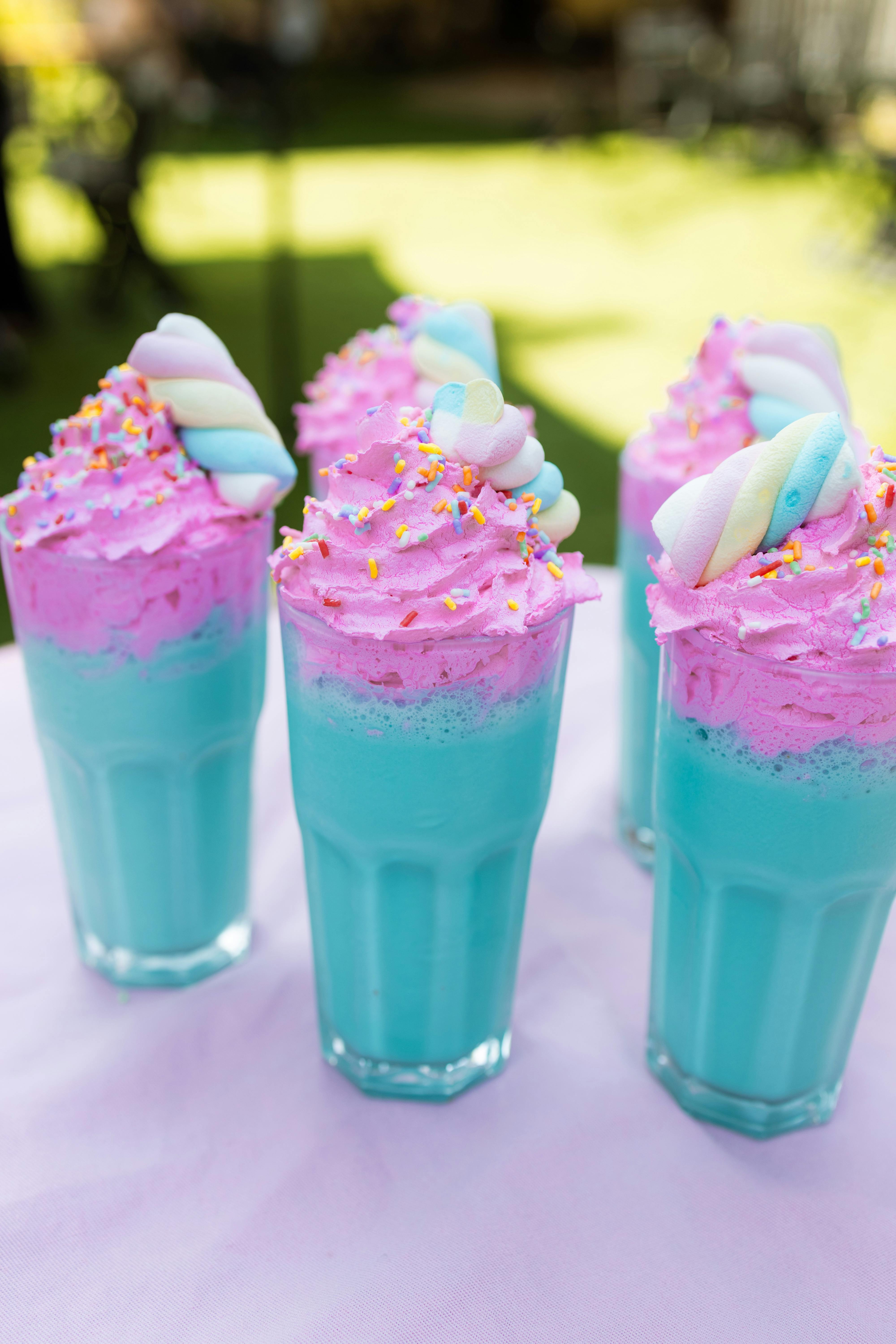Colorful Milkshakes with Whipped Cream and Sprinkles · Free Stock Photo