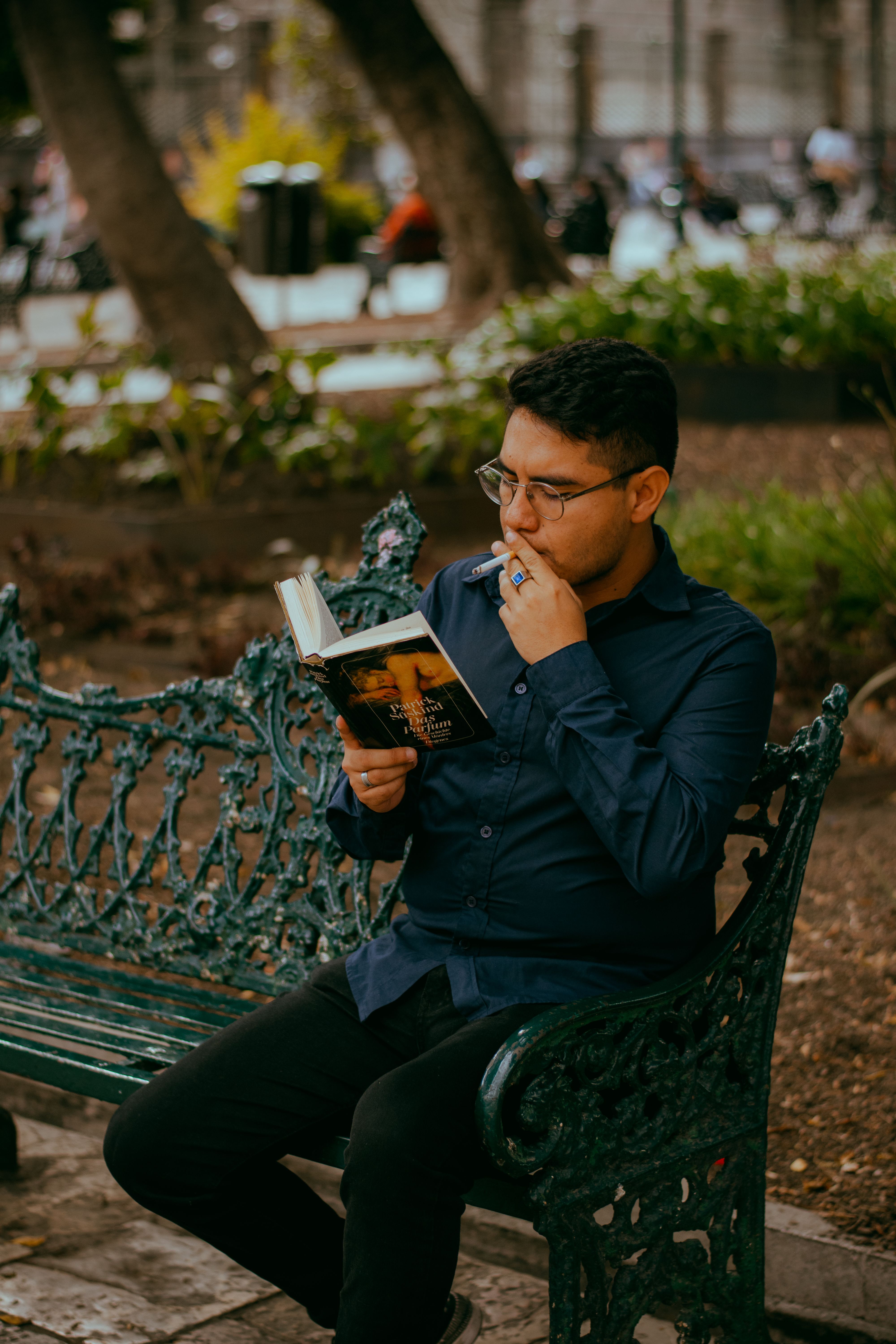 Man Reading a Book in Tranquil Urban Park · Free Stock Photo