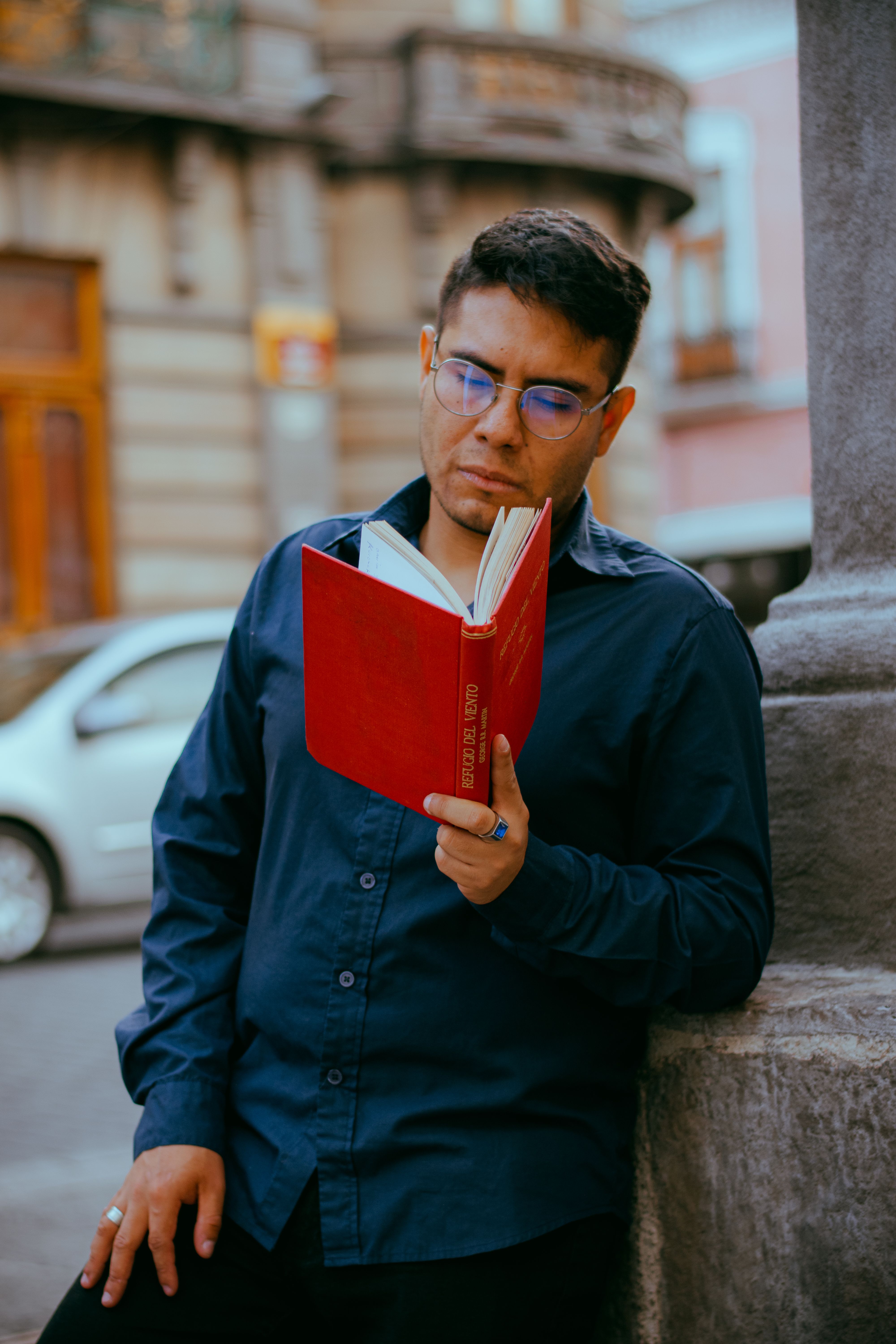 Man reading a book in an urban setting · Free Stock Photo