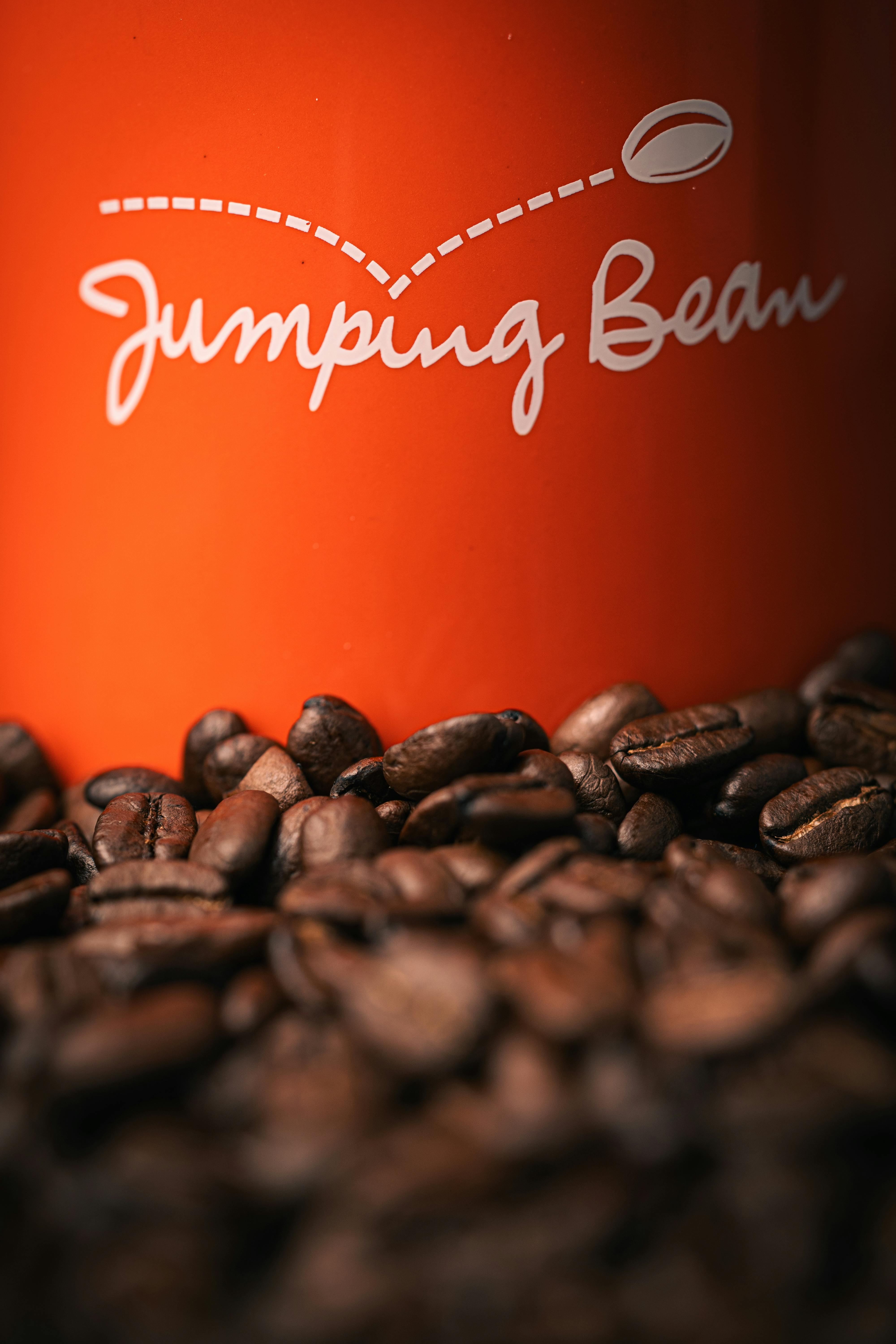 Close-Up of Jumping Bean Coffee and Logo · Free Stock Photo