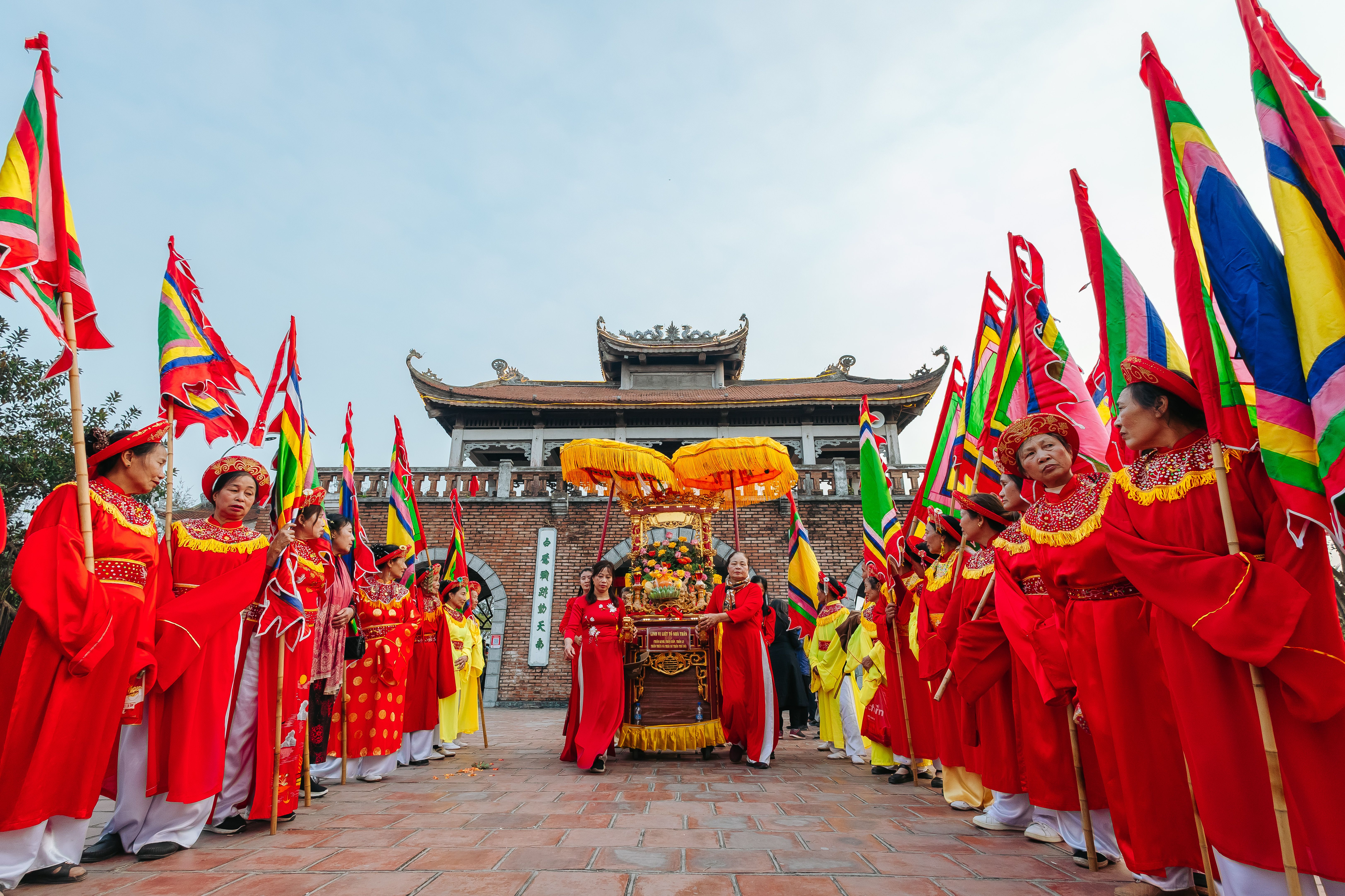 Traditional Vietnamese Festival with Vibrant Flags · Free Stock Photo