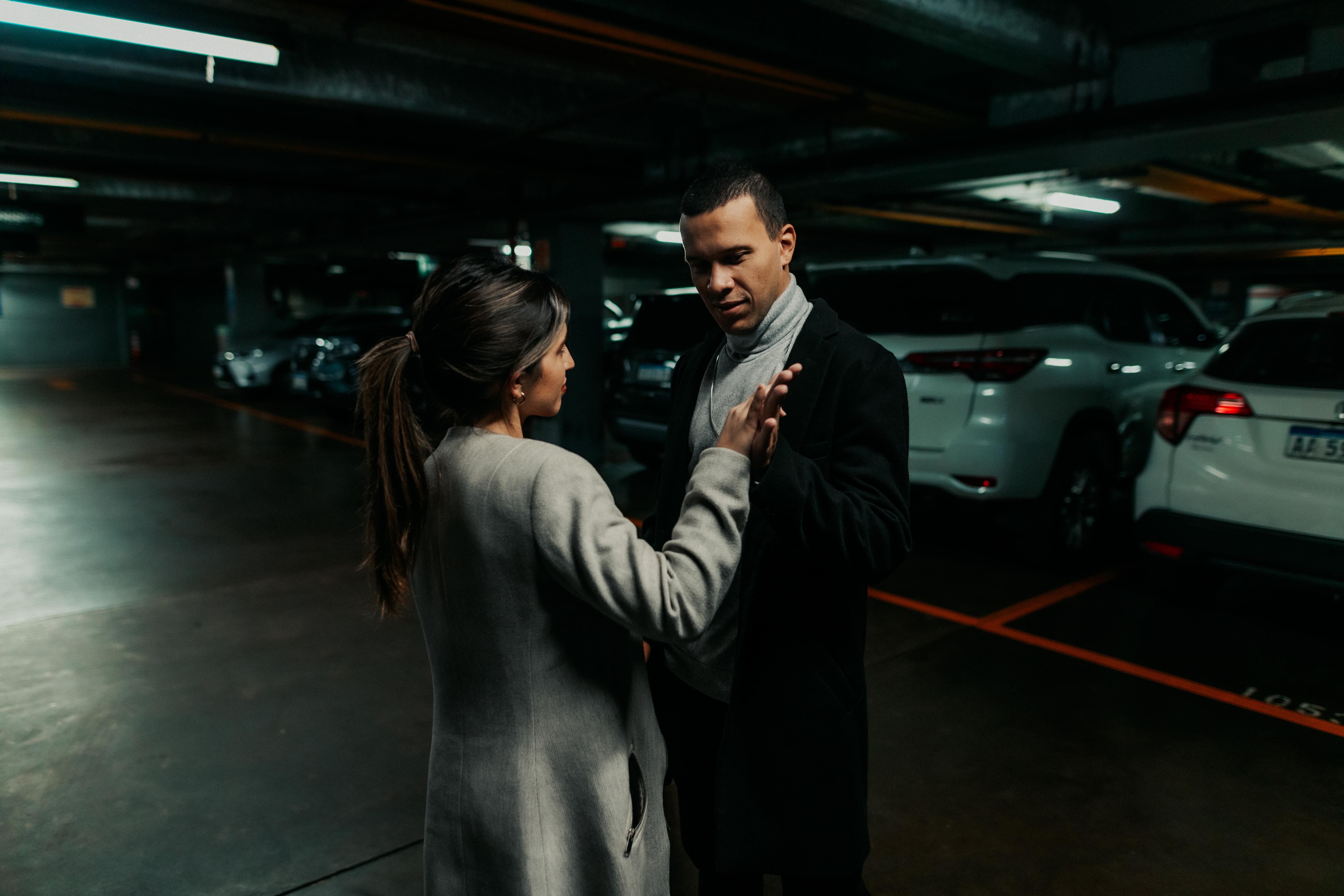 Couple Sharing a Moment in Dimly Lit Parking Garage · Free Stock Photo