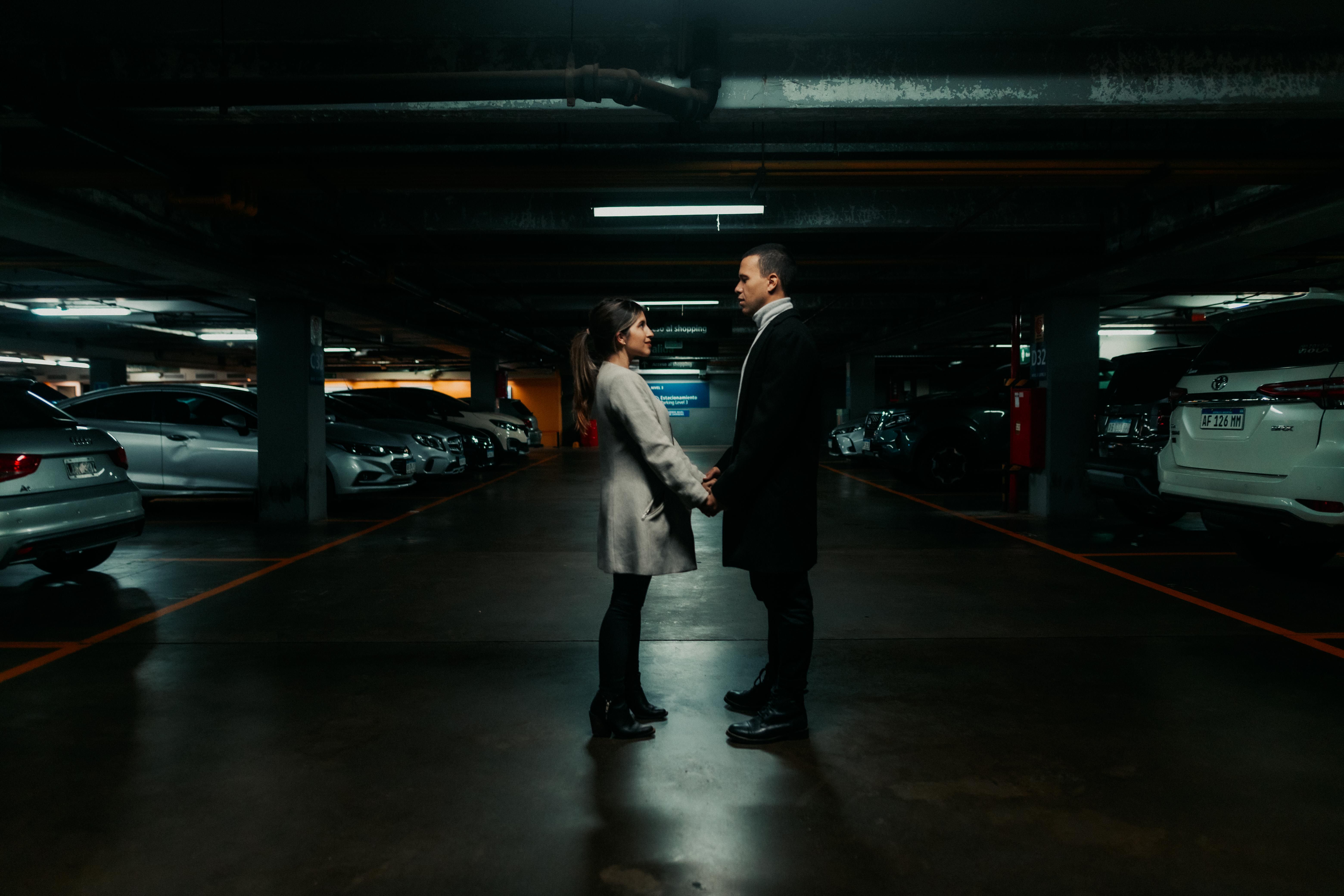 Romantic Couple Standing in Parking Garage · Free Stock Photo