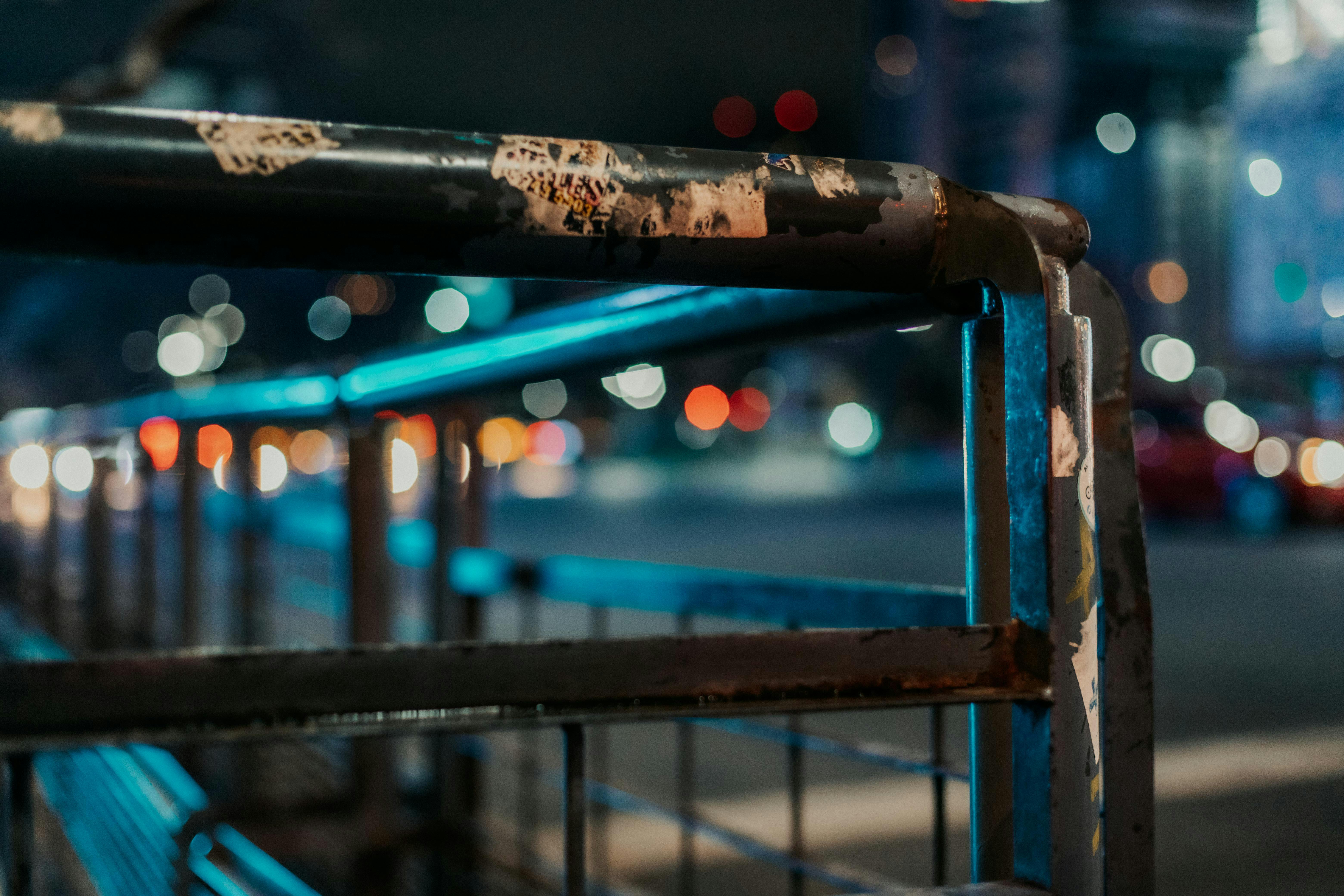 Urban Night Bokeh with Rusty Railings · Free Stock Photo