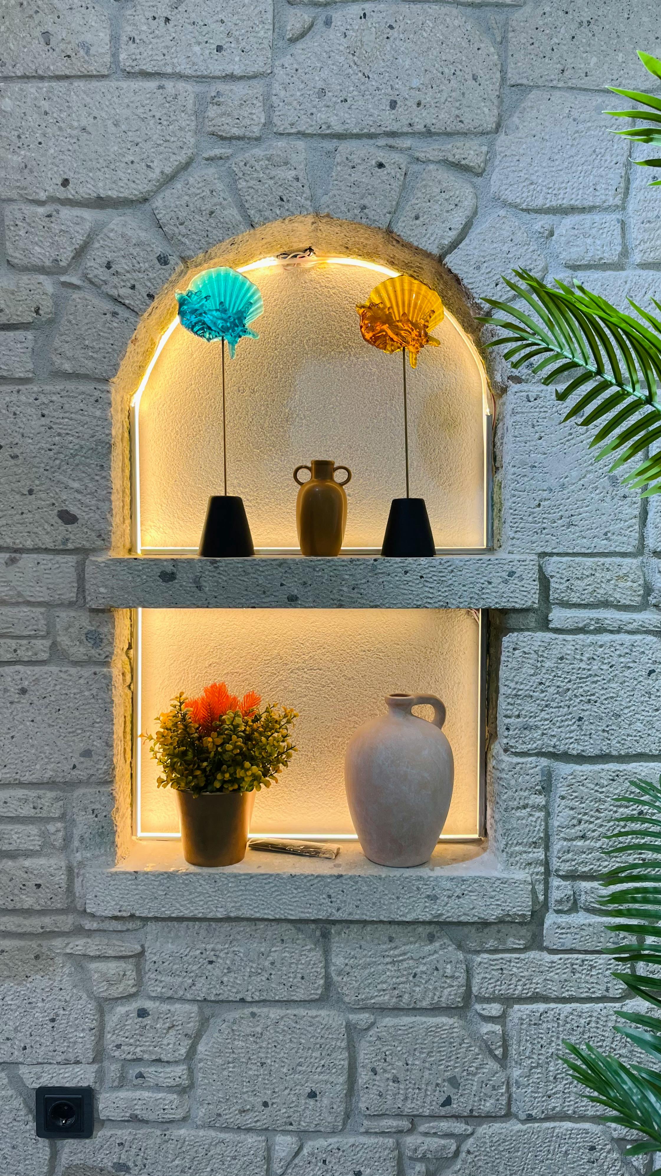 Elegant Stone Wall Shelf Display with Lighting · Free Stock Photo