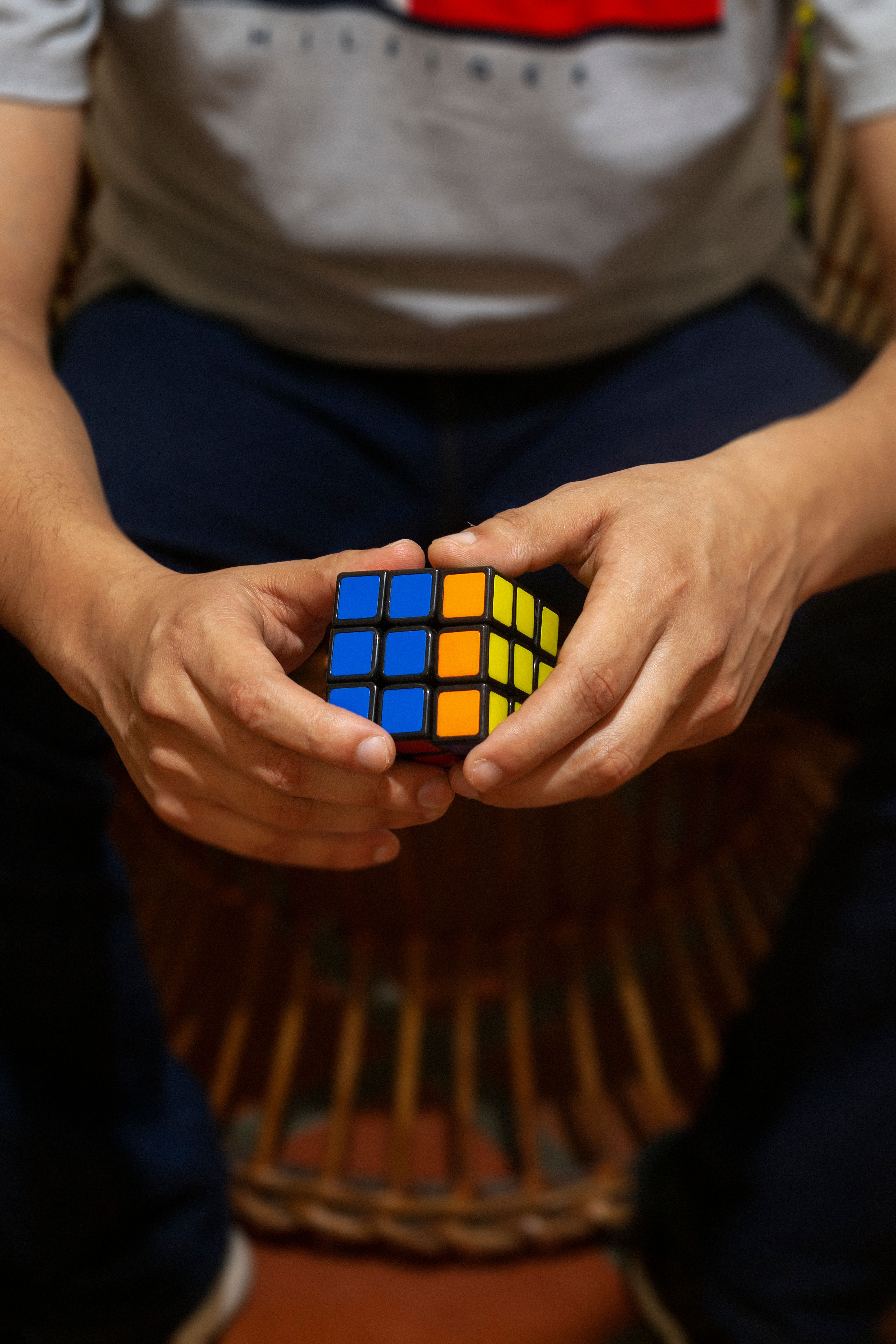 Hands Solving a Vibrant Rubik's Cube Puzzle · Free Stock Photo